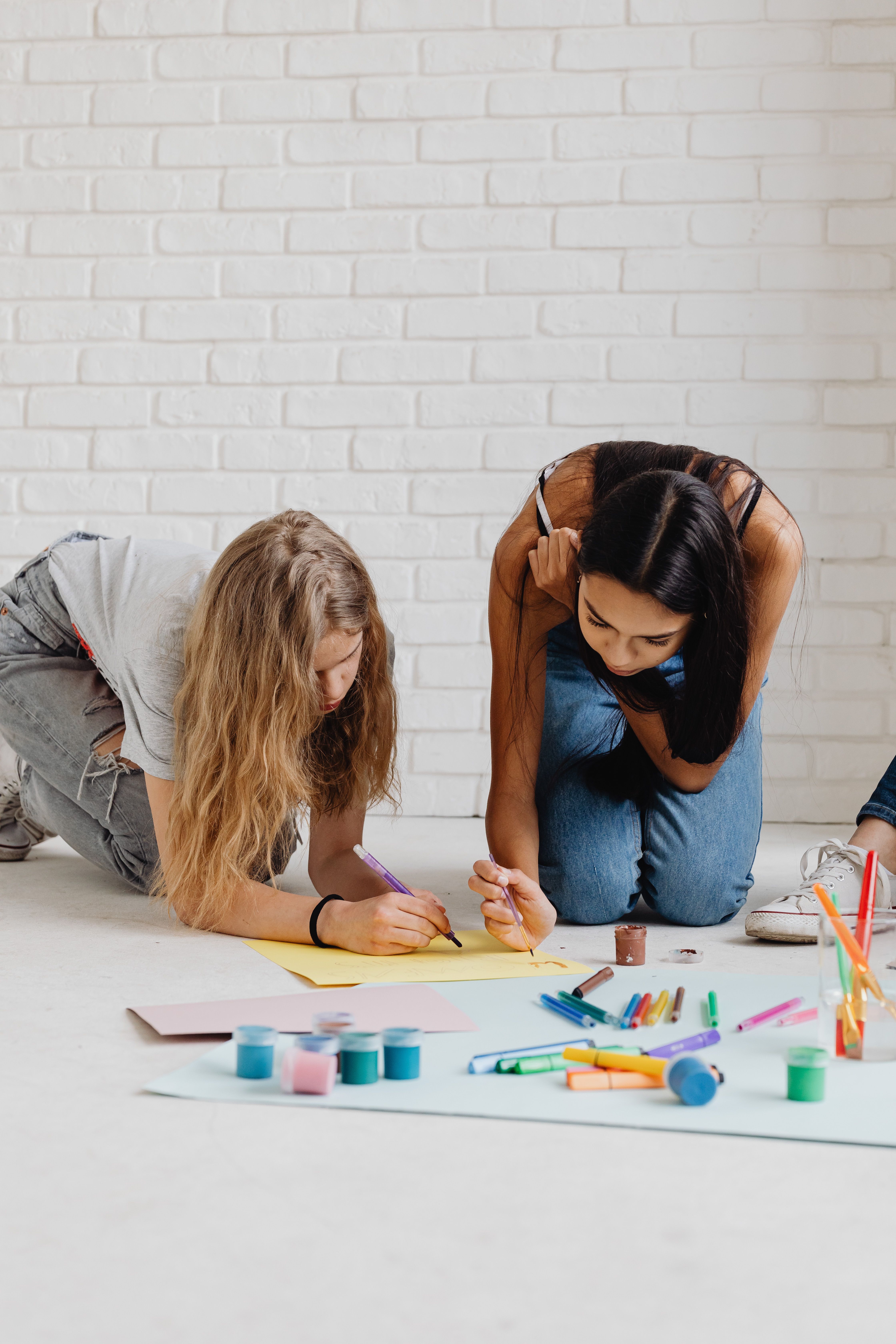 The Girls Paint a Poster on the floor · Free Stock Photo