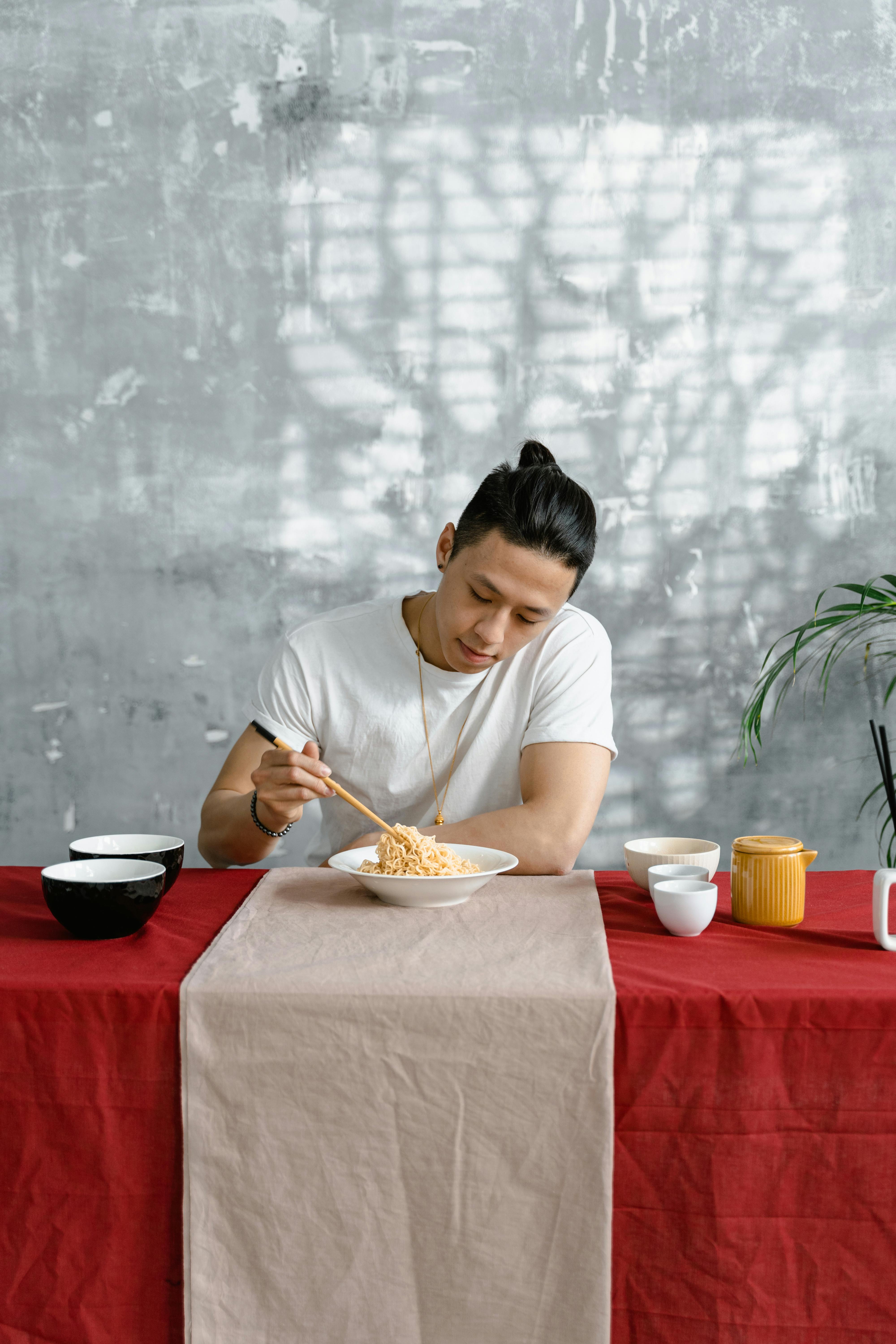 Man in White Shirt Eating Noodles · Free Stock Photo