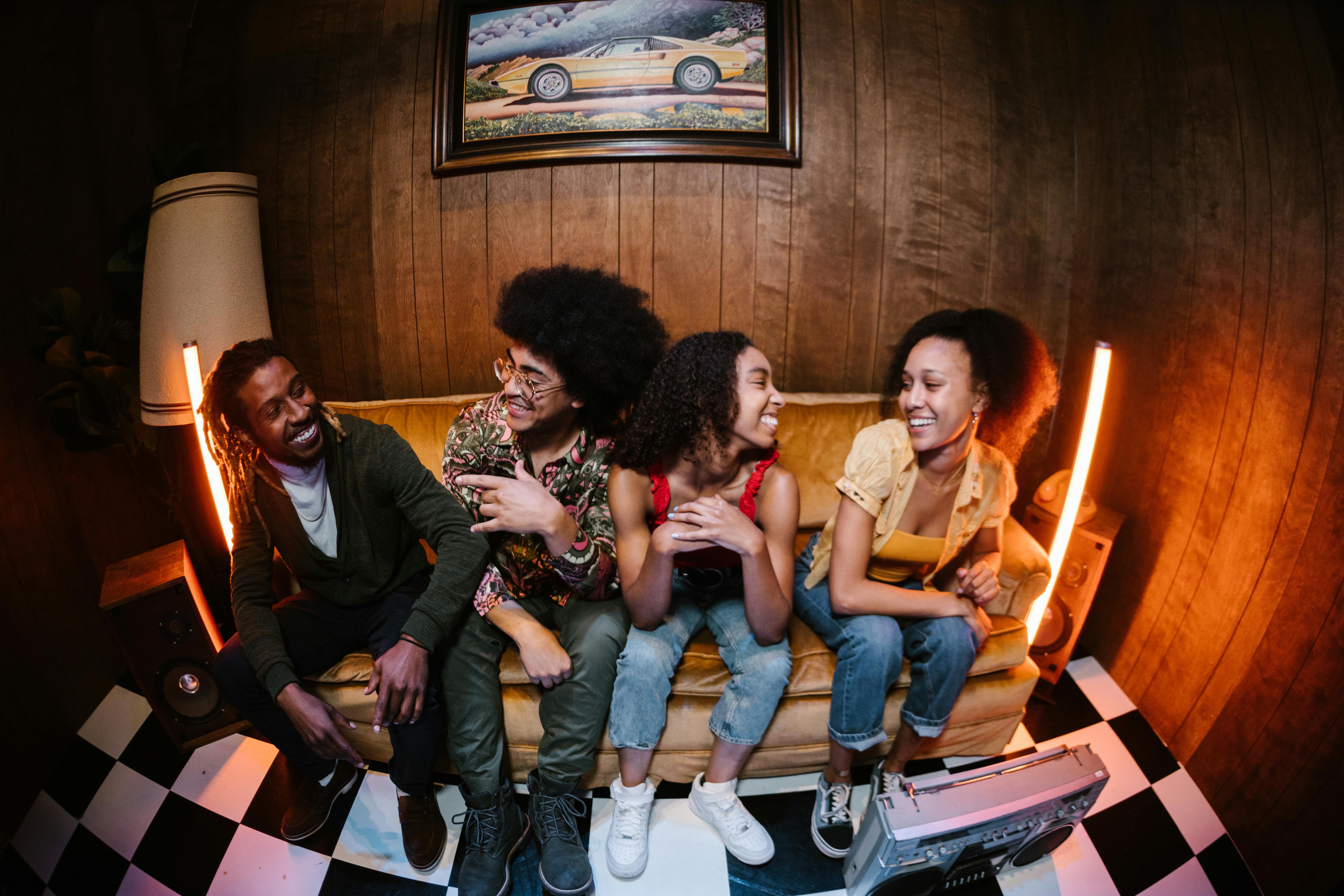 Group of People Sitting on Couch · Free Stock Photo