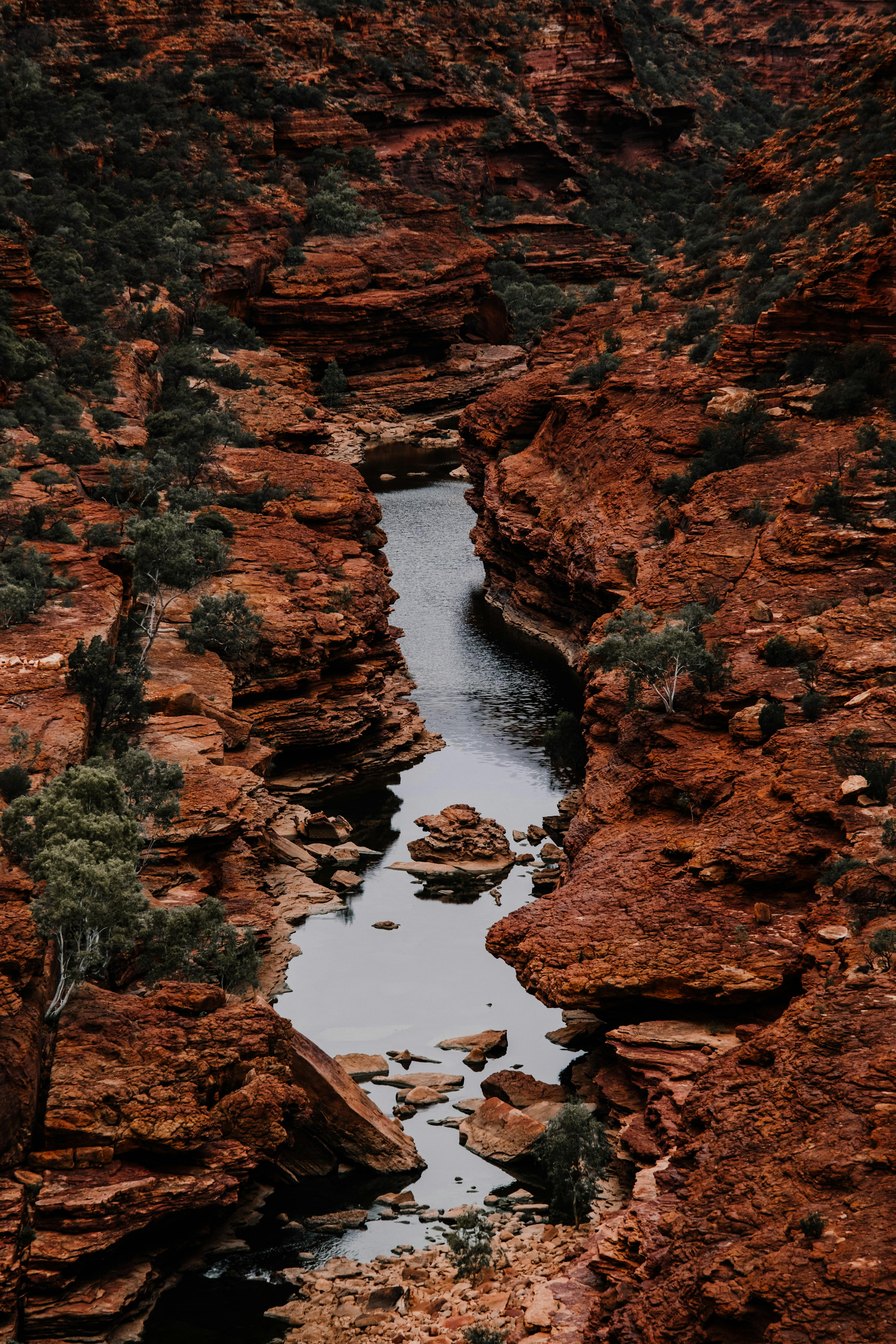 Aerial Footage of Stream between Brown Rock Formation · Free Stock Photo