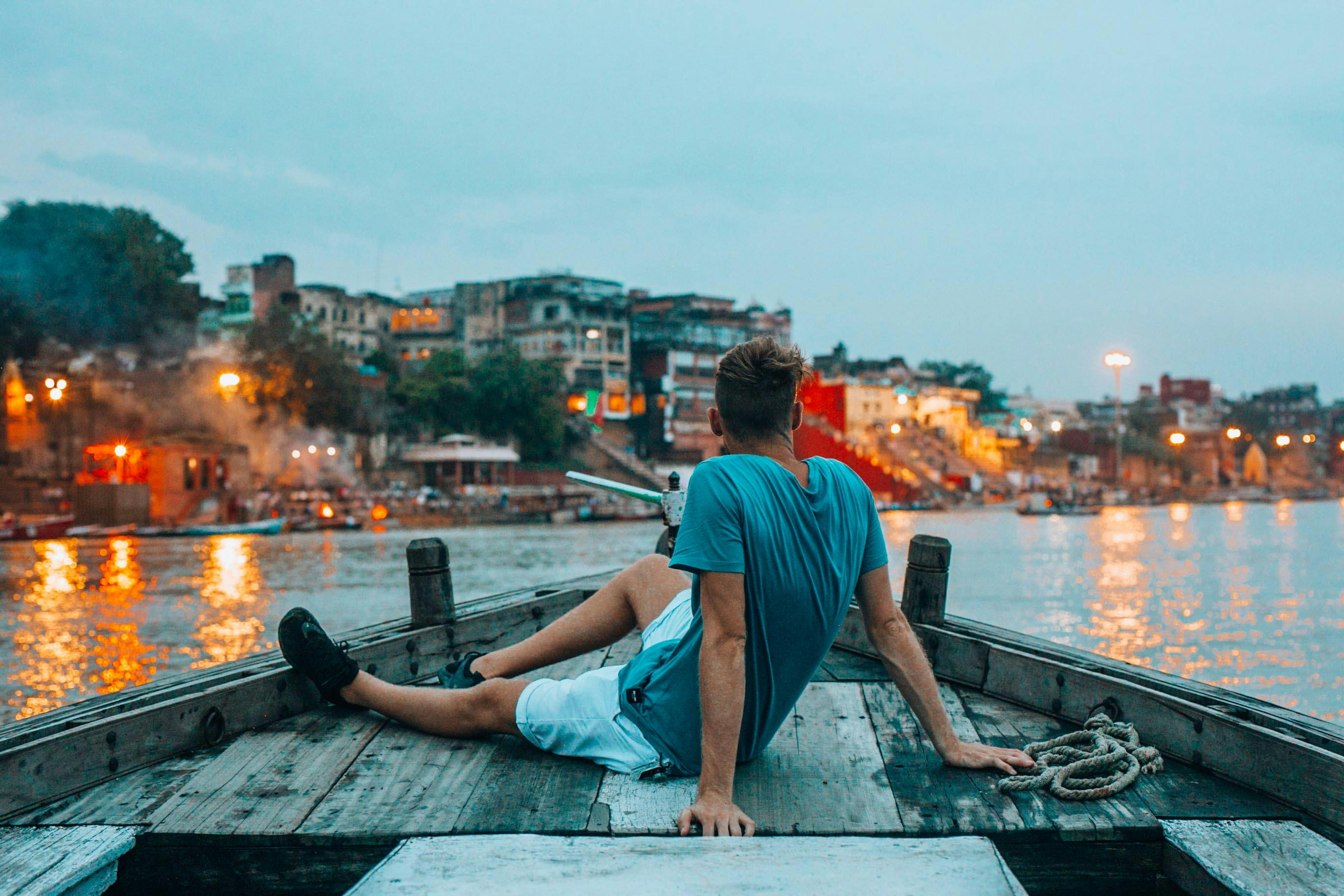 A Man Sitting on the Wooden Boat · Free Stock Photo