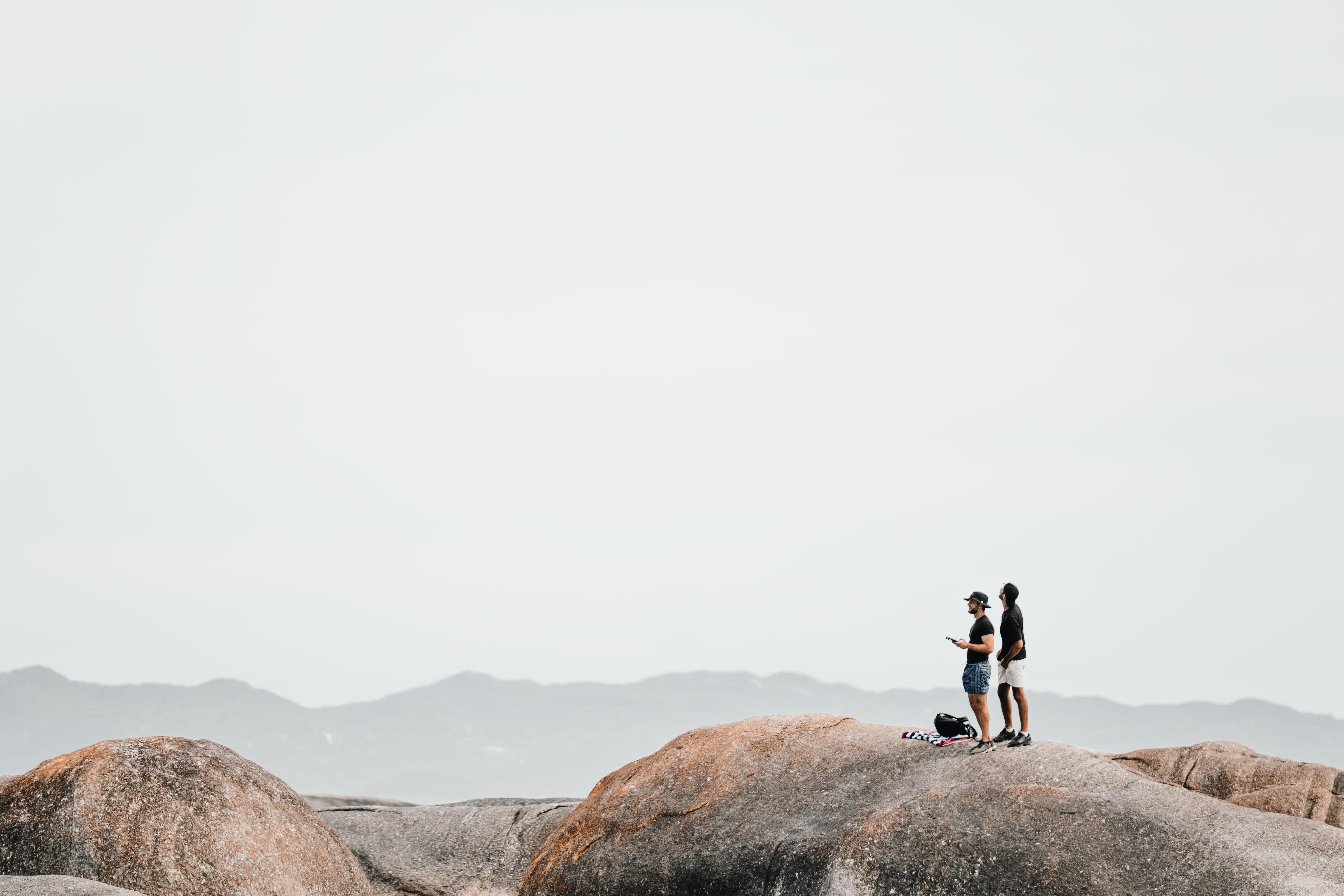 Men Standing on Rock in Nature Landscape · Free Stock Photo