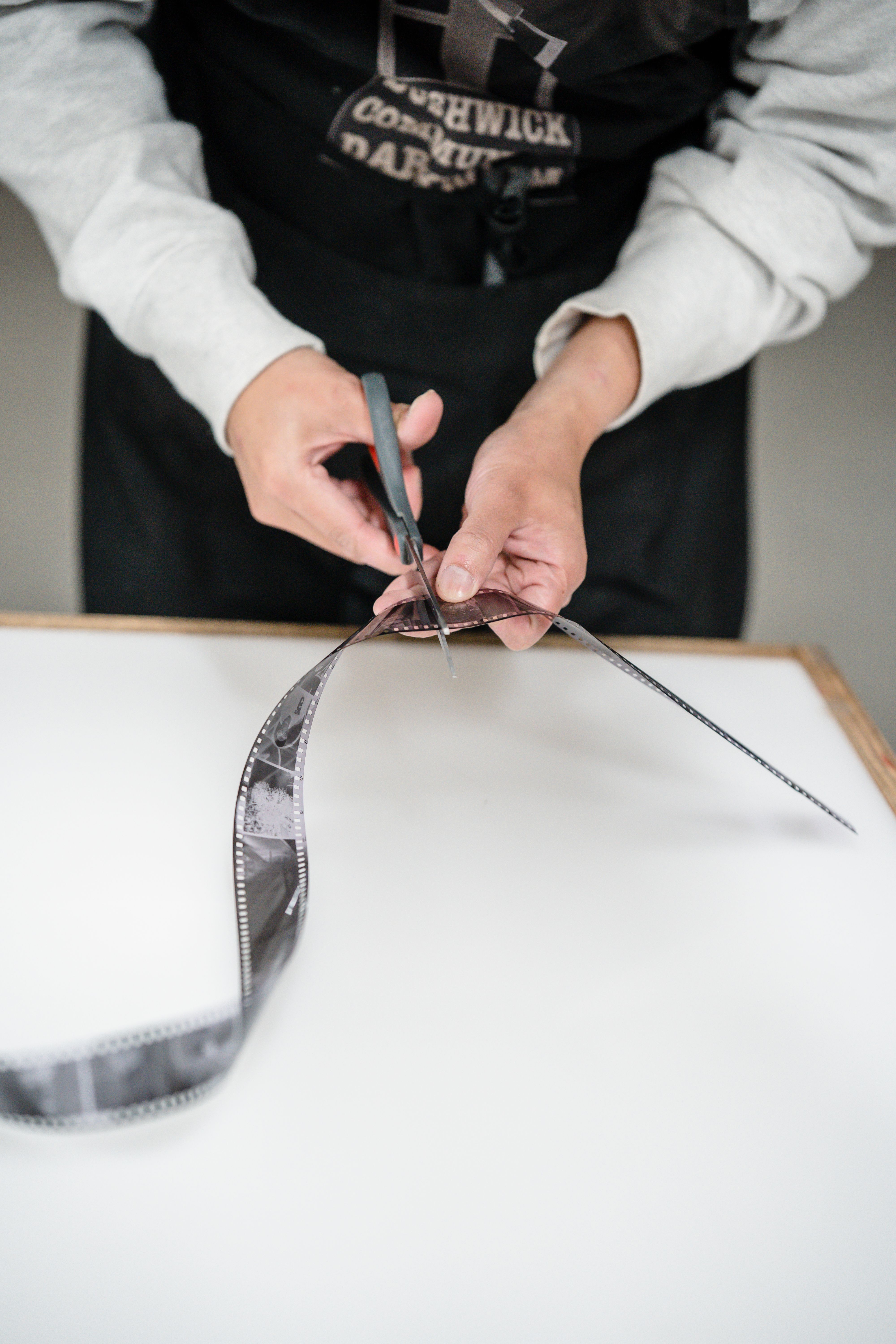 Man Cutting an Undeveloped Film Roll · Free Stock Photo