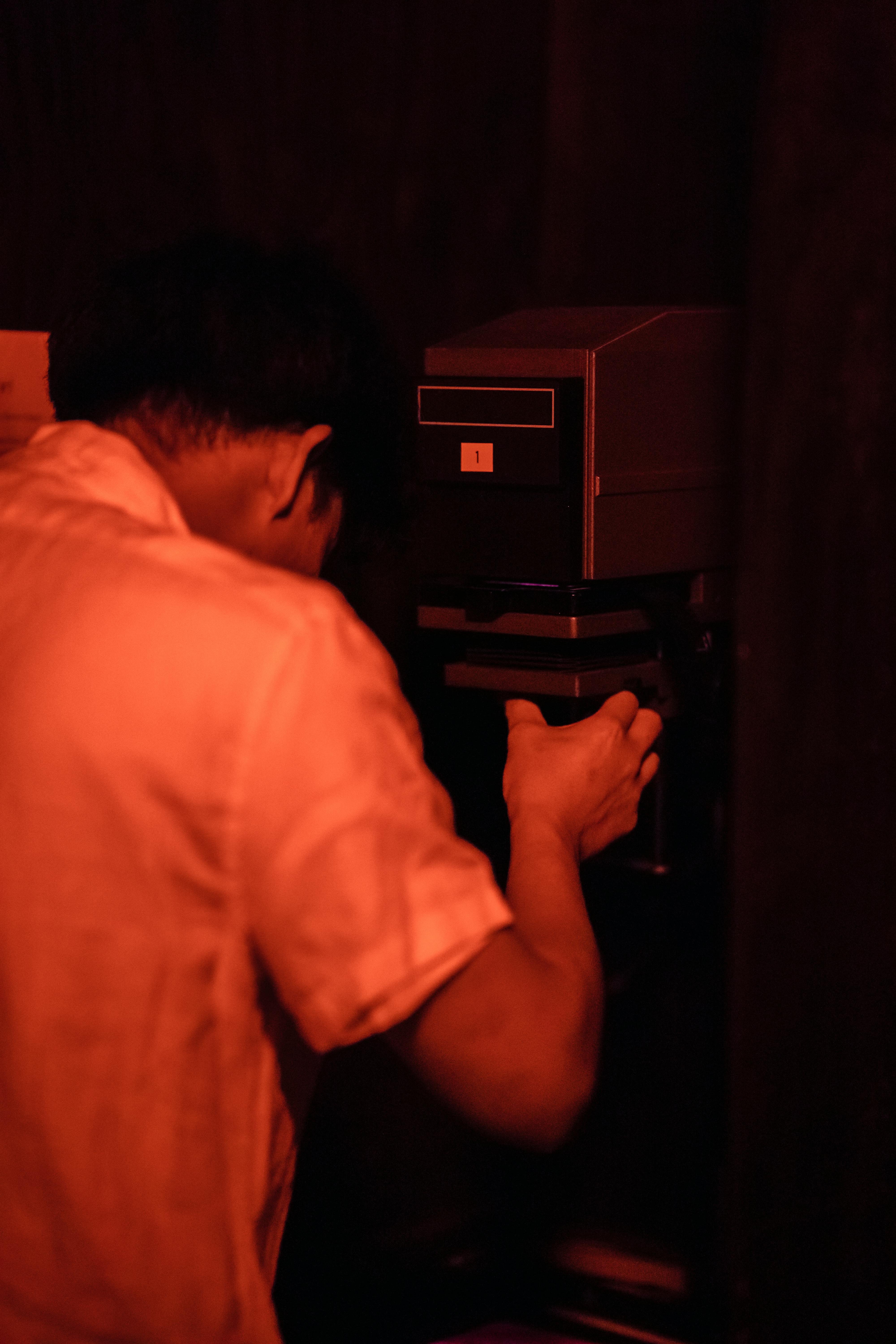 Man Developing Pictures in a Darkroom · Free Stock Photo
