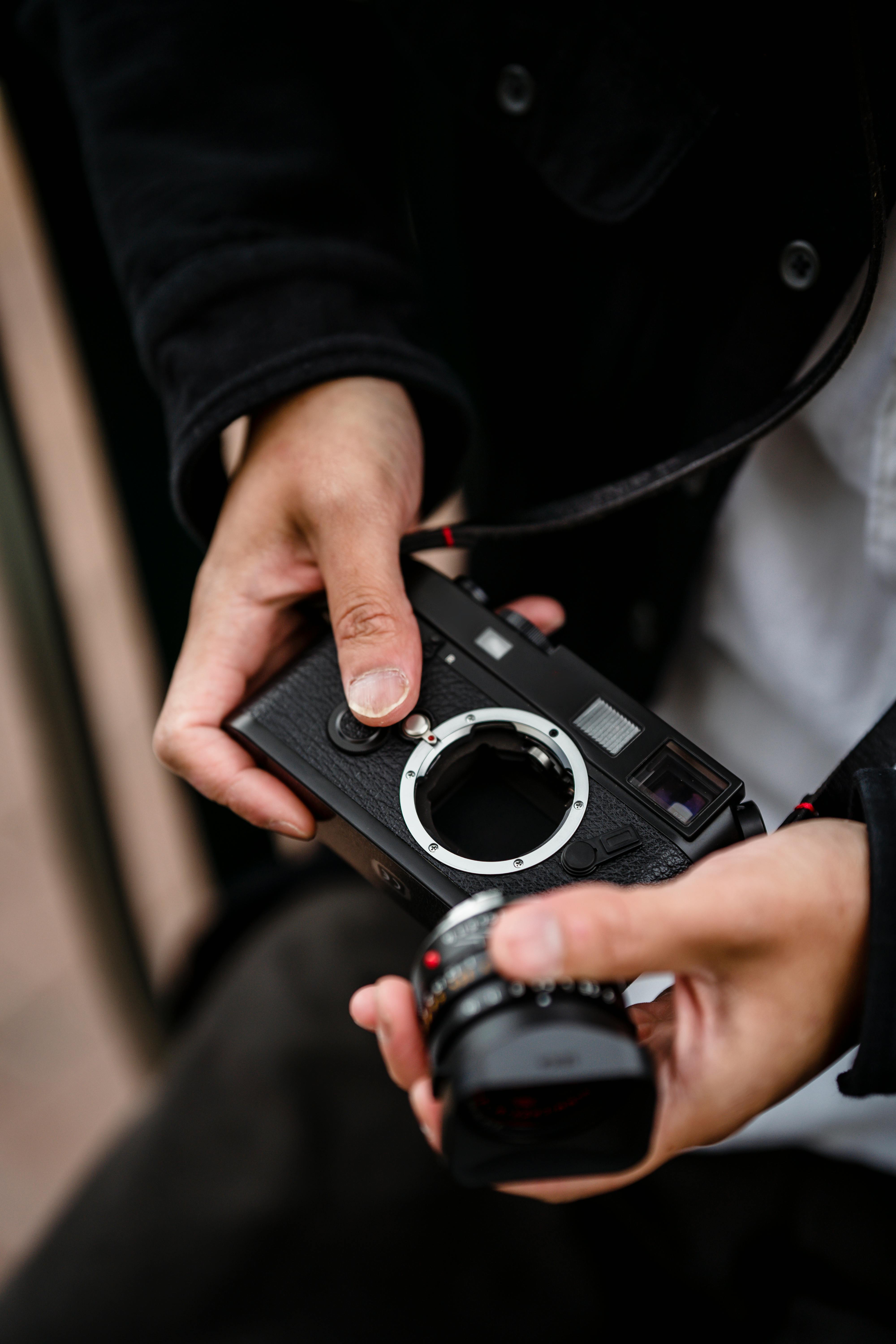 Close Up of Photographer Hands Holding Camera · Free Stock Photo