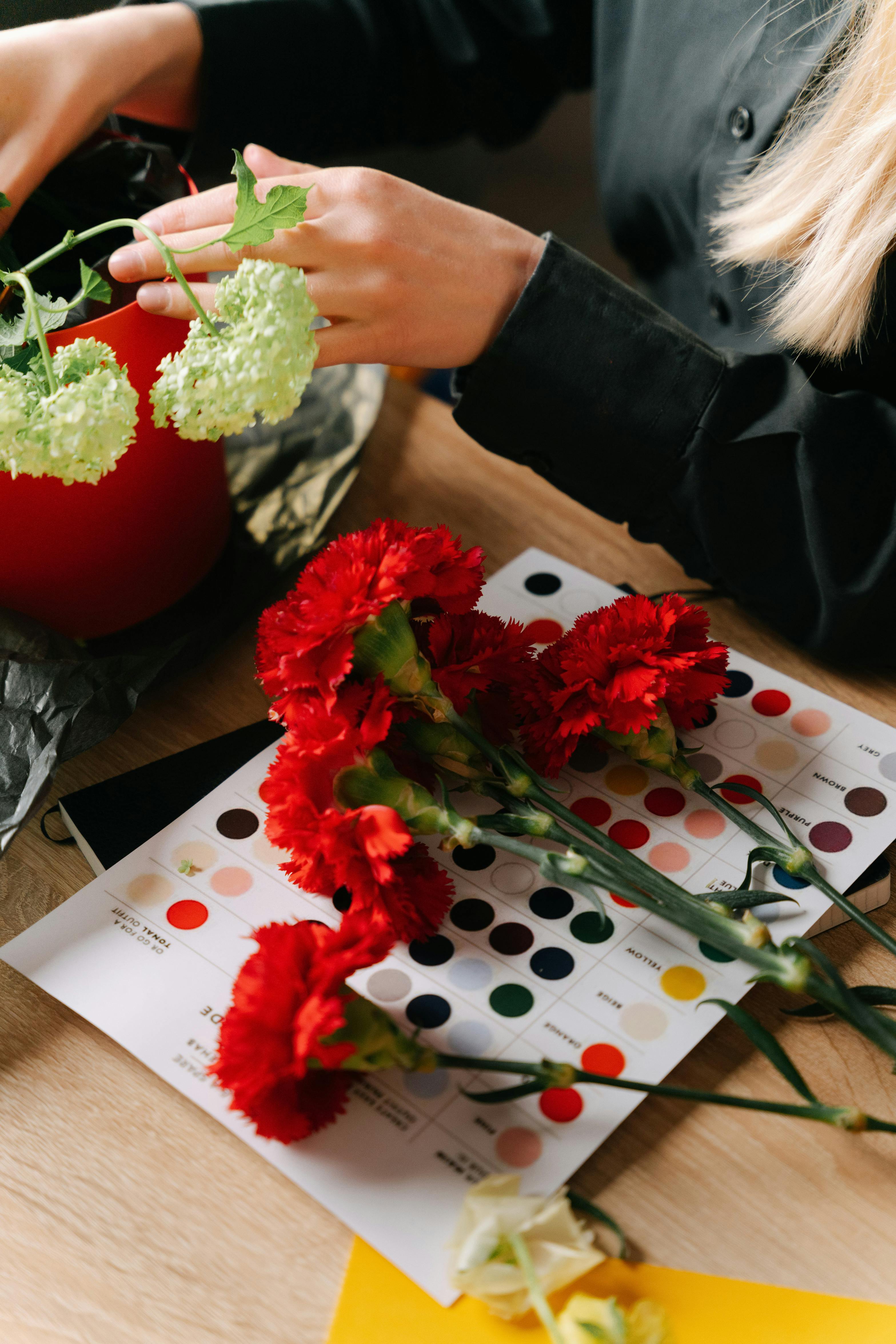 A Red Flowers on a Wooden Table · Free Stock Photo