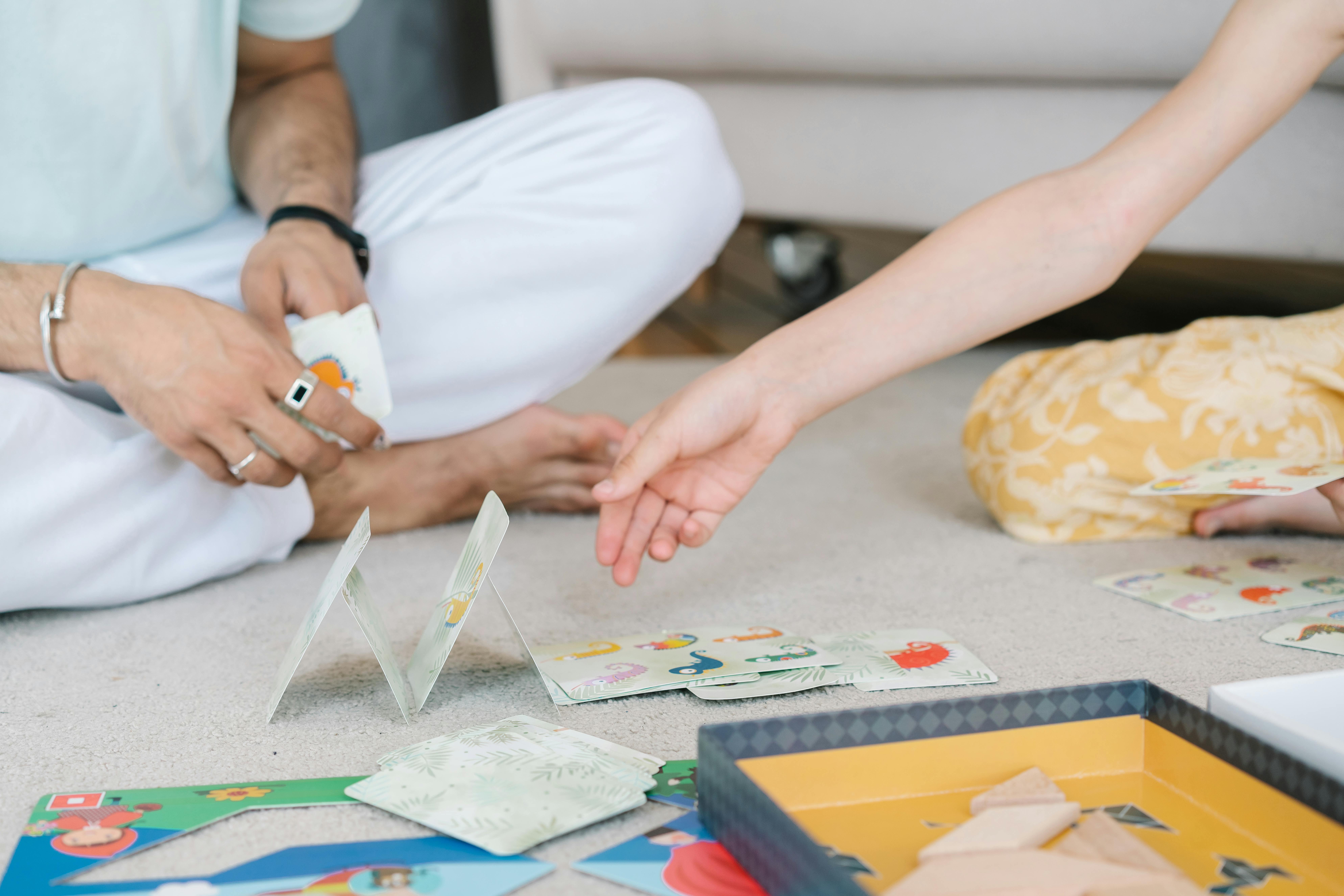 A Close-Up Shot of People Playing Cards · Free Stock Photo