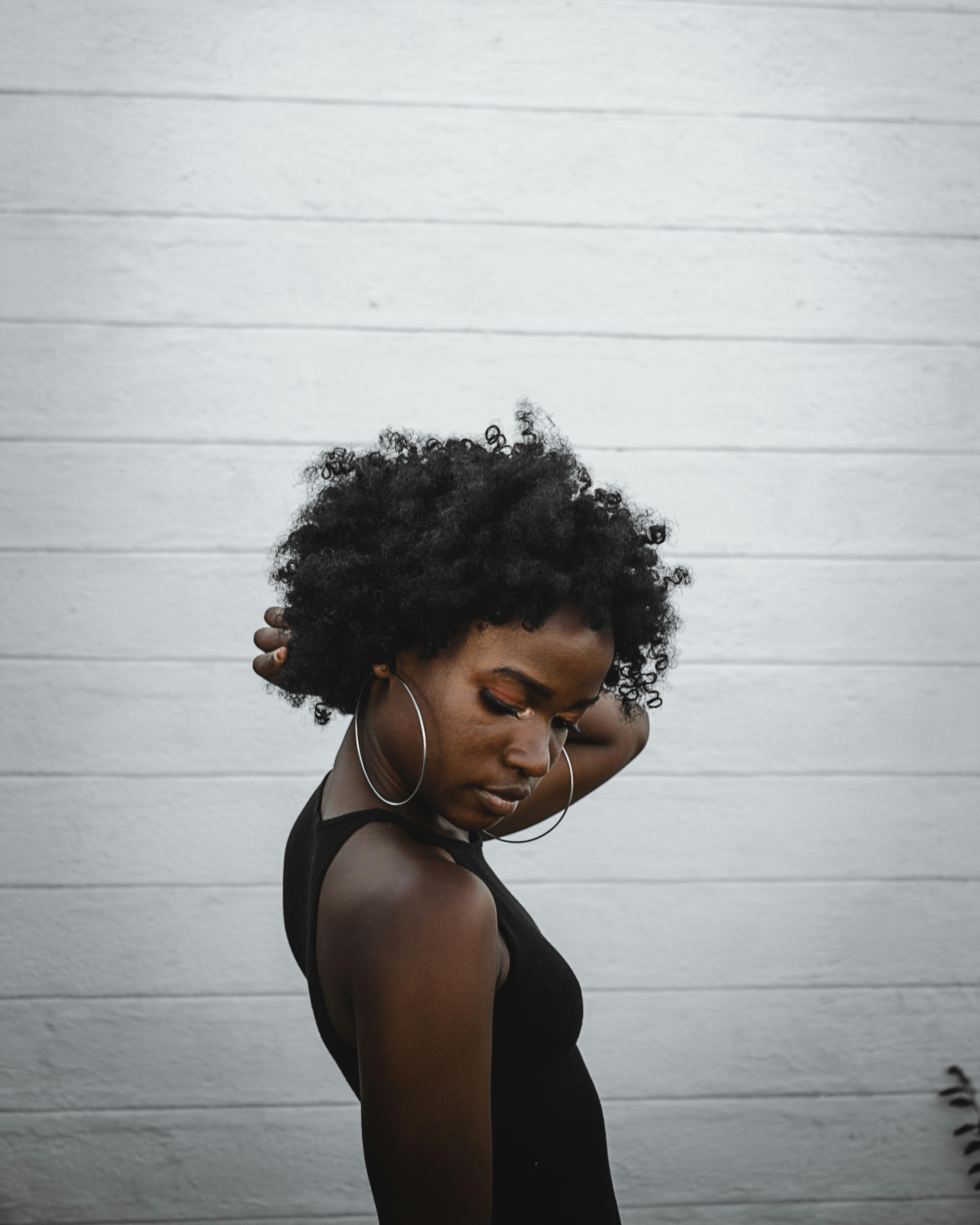 Woman Looking Over Her Shoulder Pose in Black Tank Top · Free Stock Photo