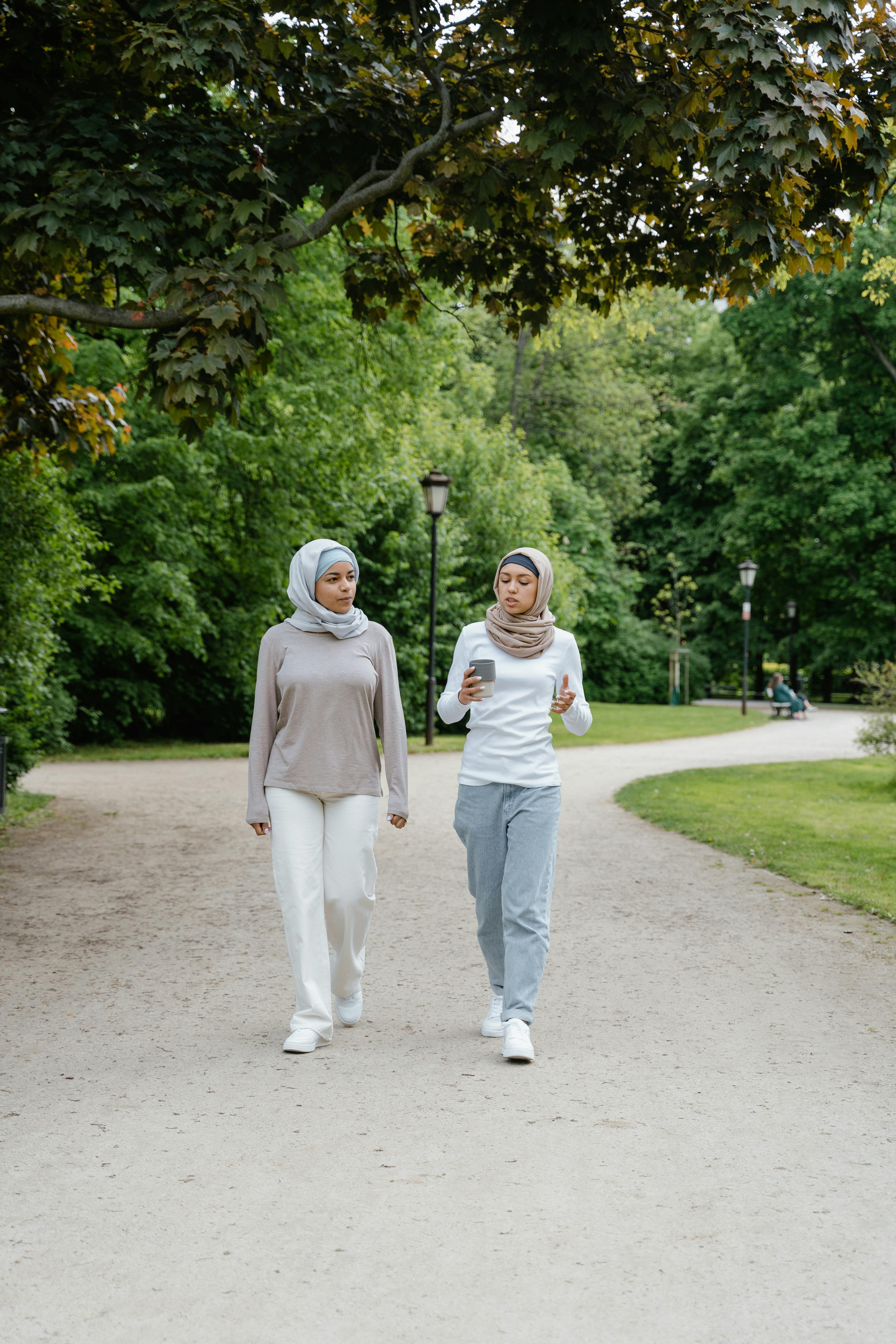 Women Walking at the Park while Having Conversation · Free Stock Photo