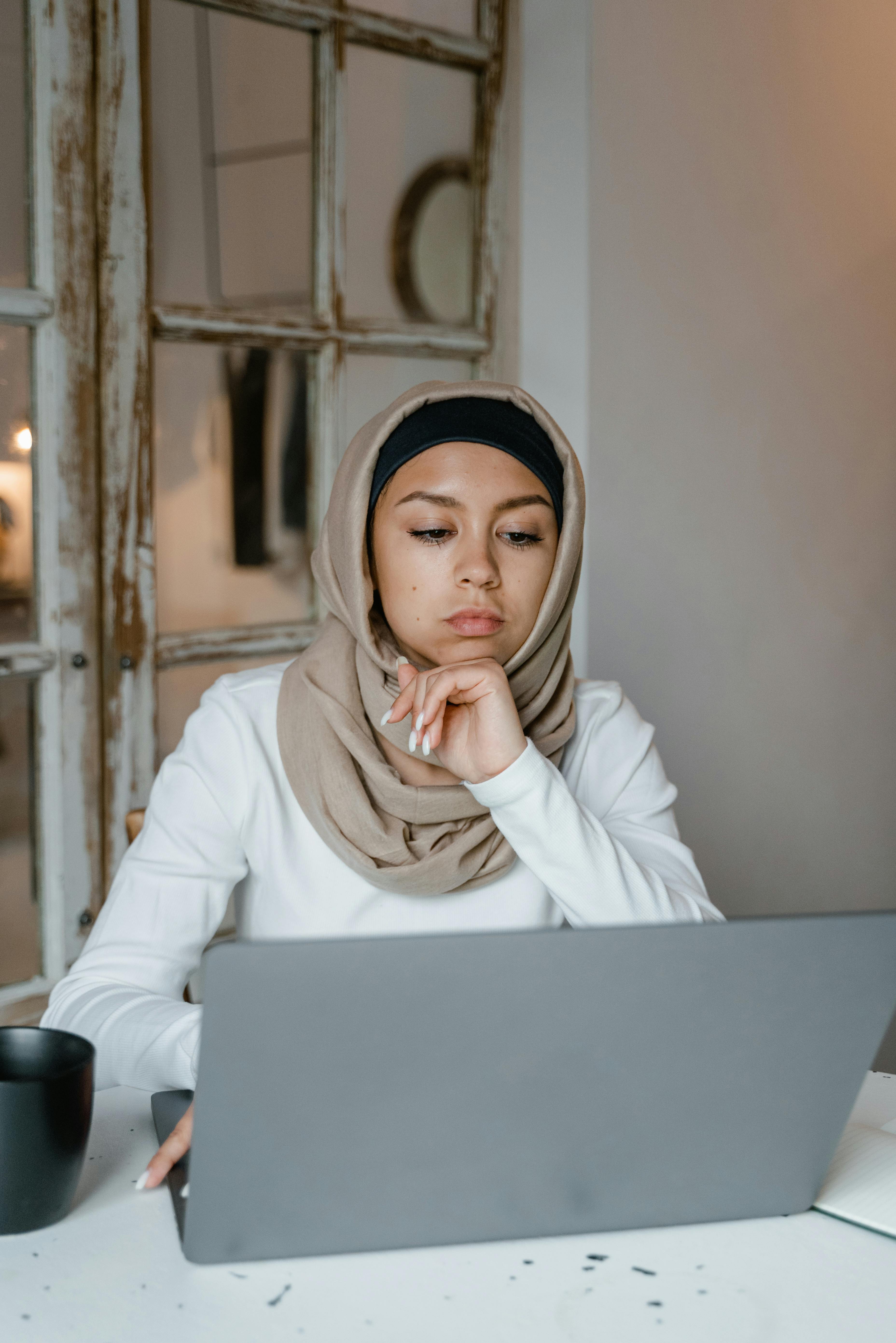 A Woman in Hijab using Laptop · Free Stock Photo
