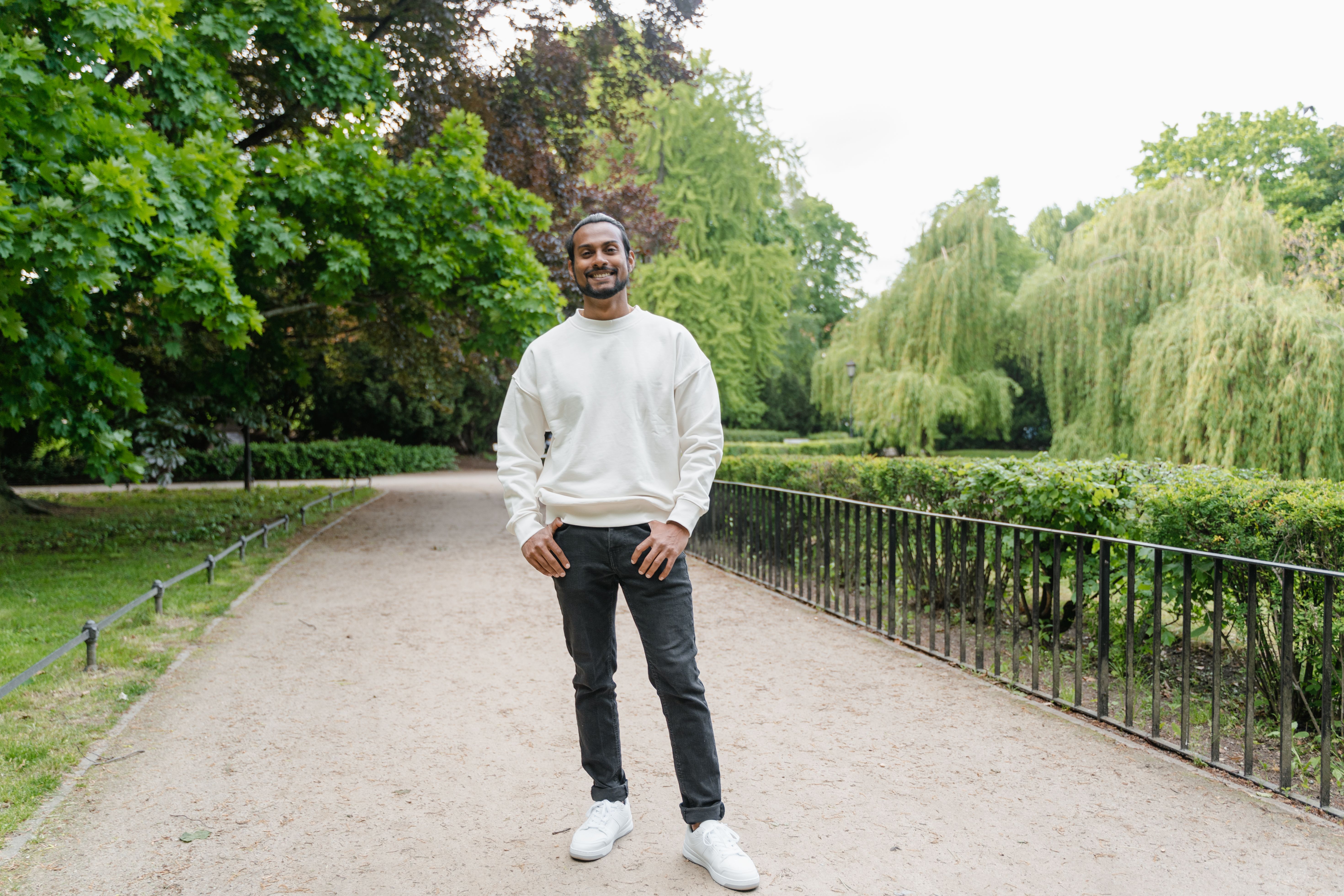 Man Standing in a Walkway in the Park · Free Stock Photo