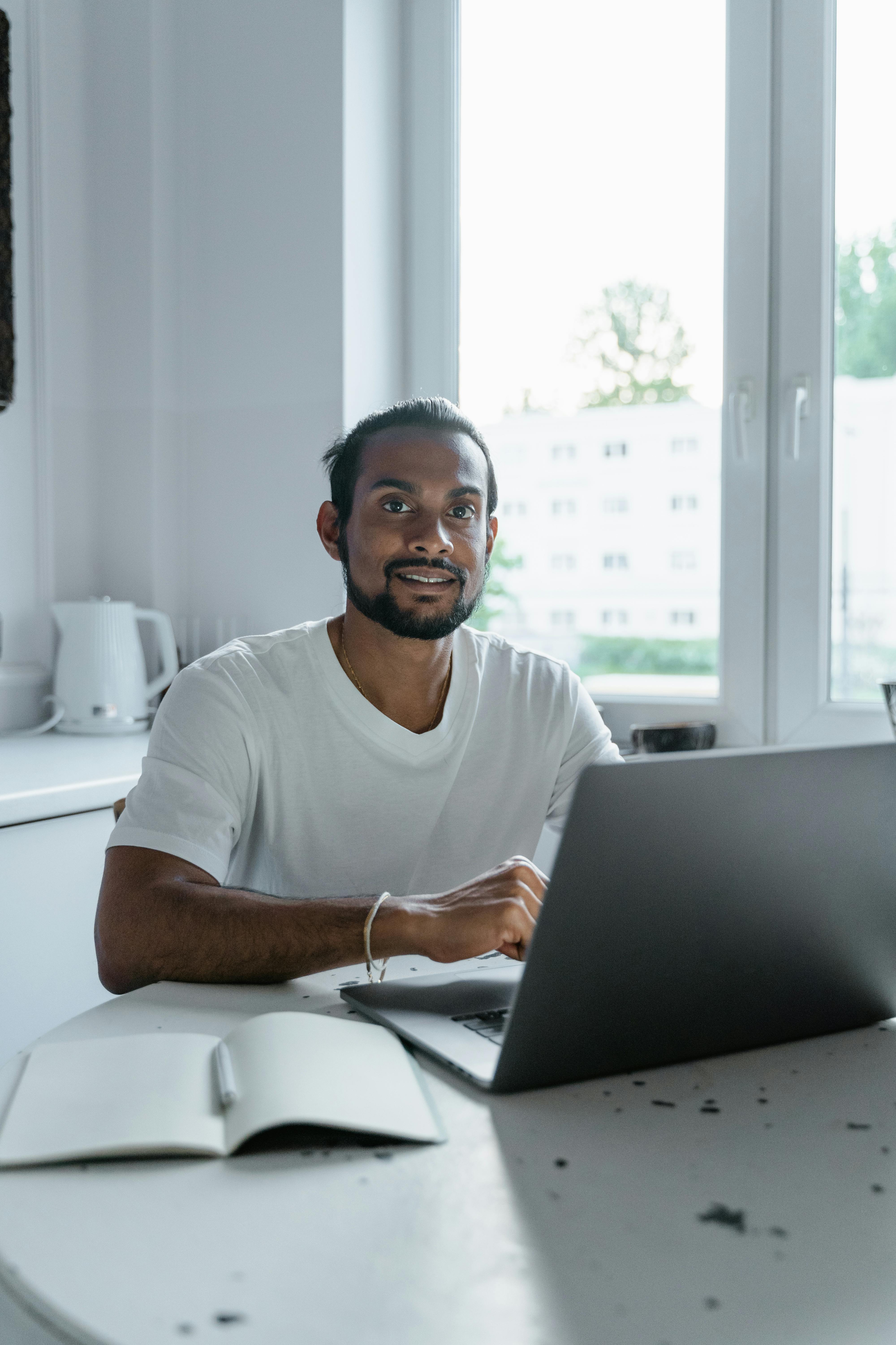 Man Sitting at the Table with Laptop · Free Stock Photo