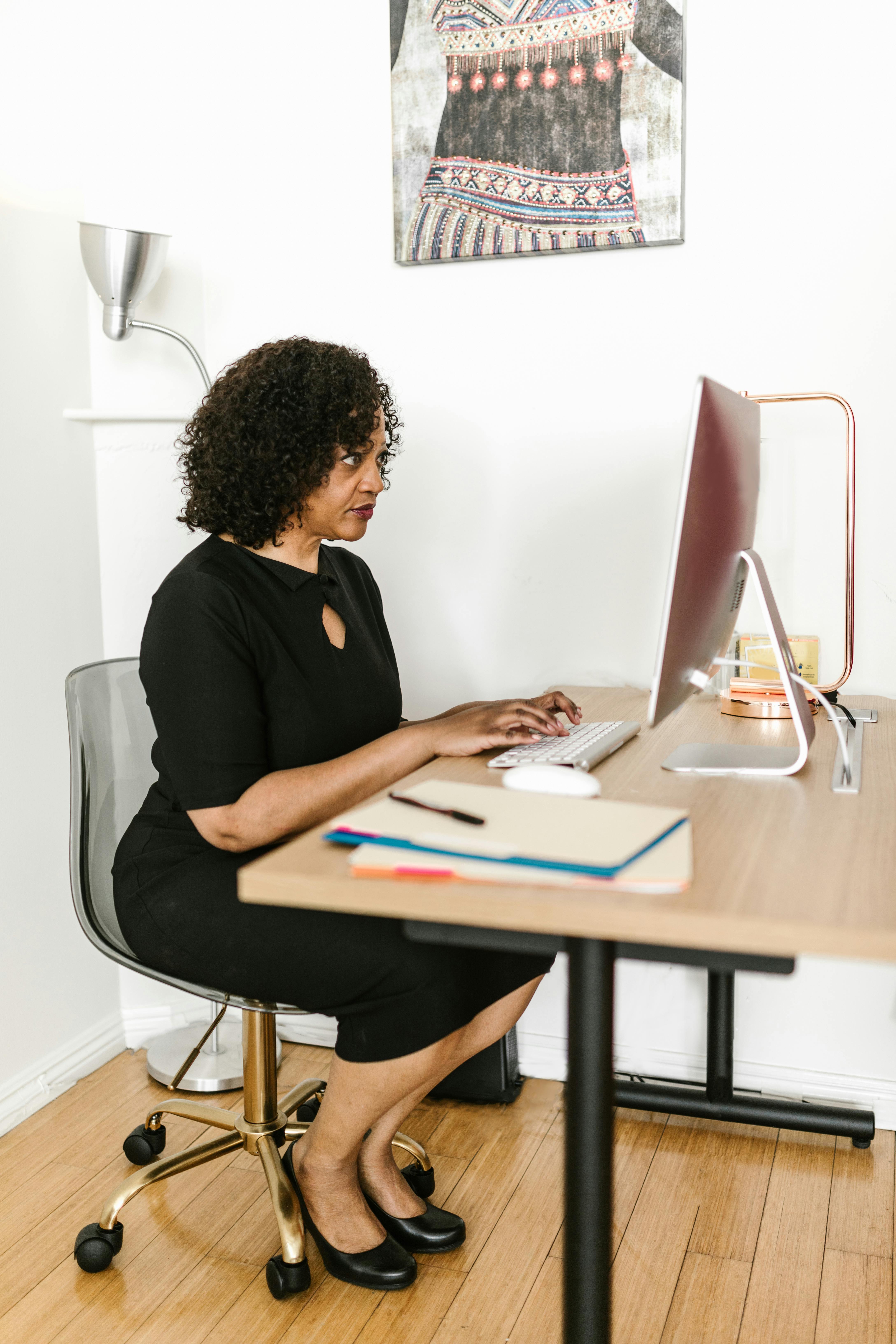 Woman in Black Dress Working Using Desktop Computer · Free Stock Photo