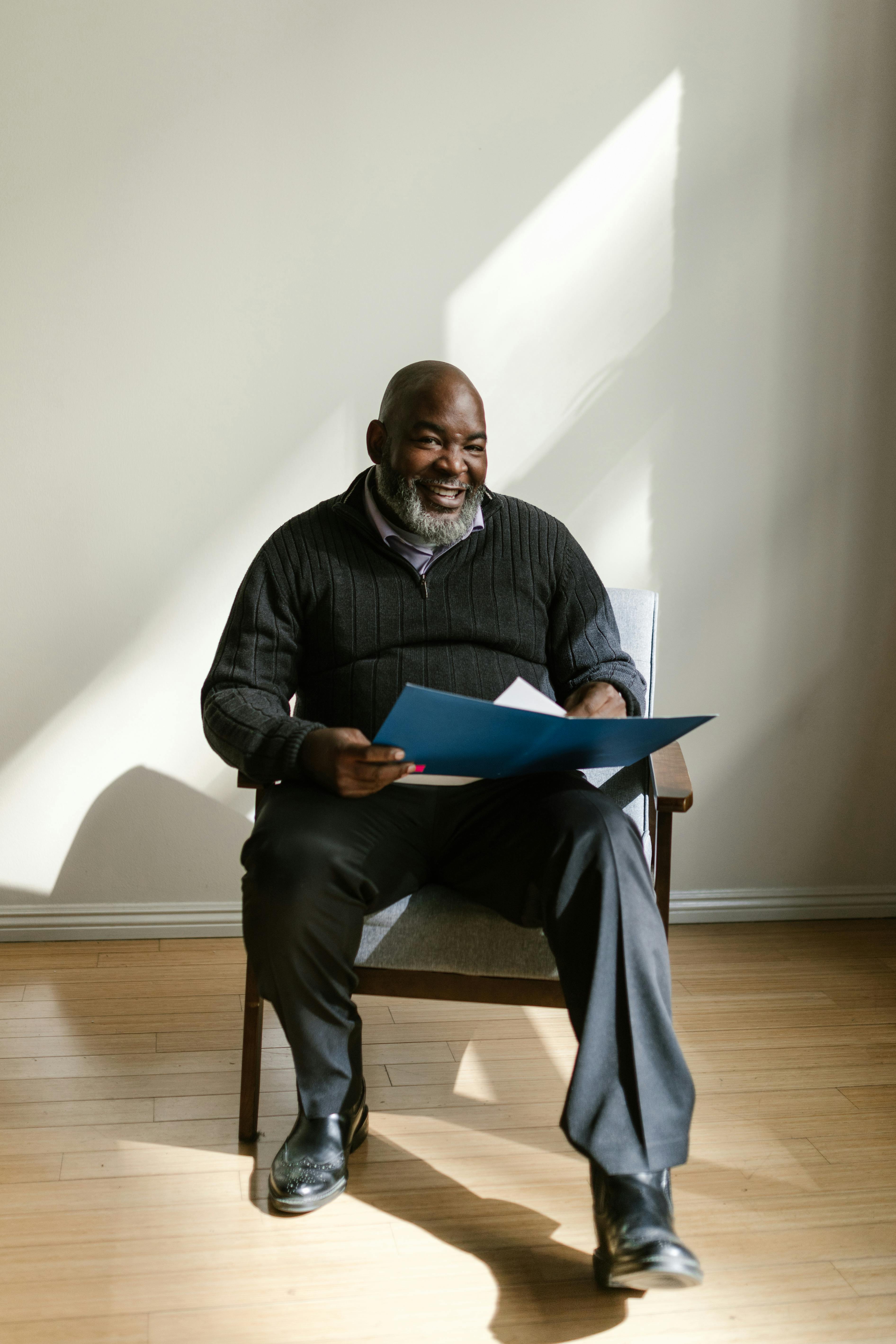 A Man Smiling While Texting · Free Stock Photo