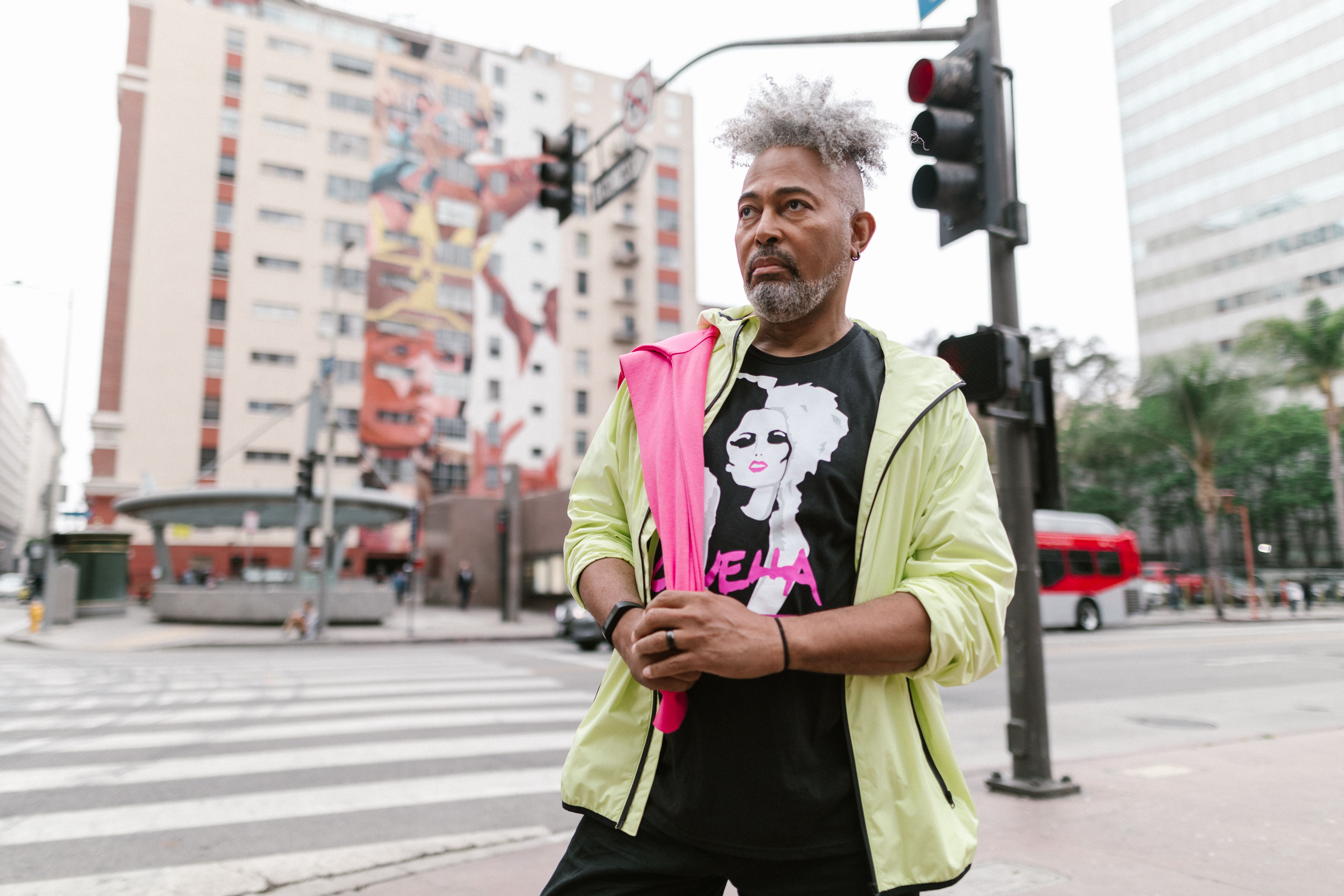 Man in Neon Green Jacket Standing near the Traffic Light · Free Stock Photo