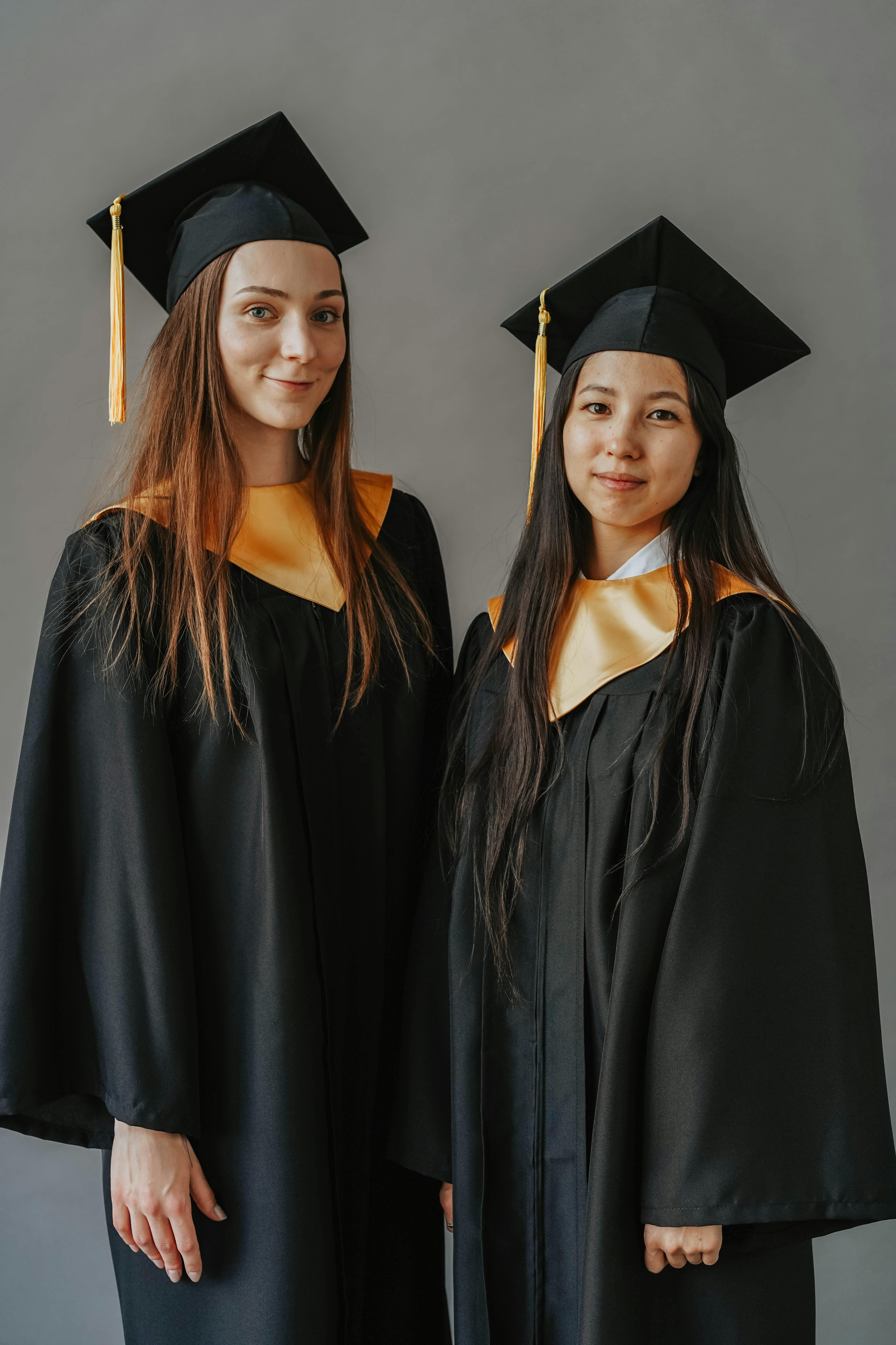 Female Former Classmates wearing Graduation Gown · Free Stock Photo