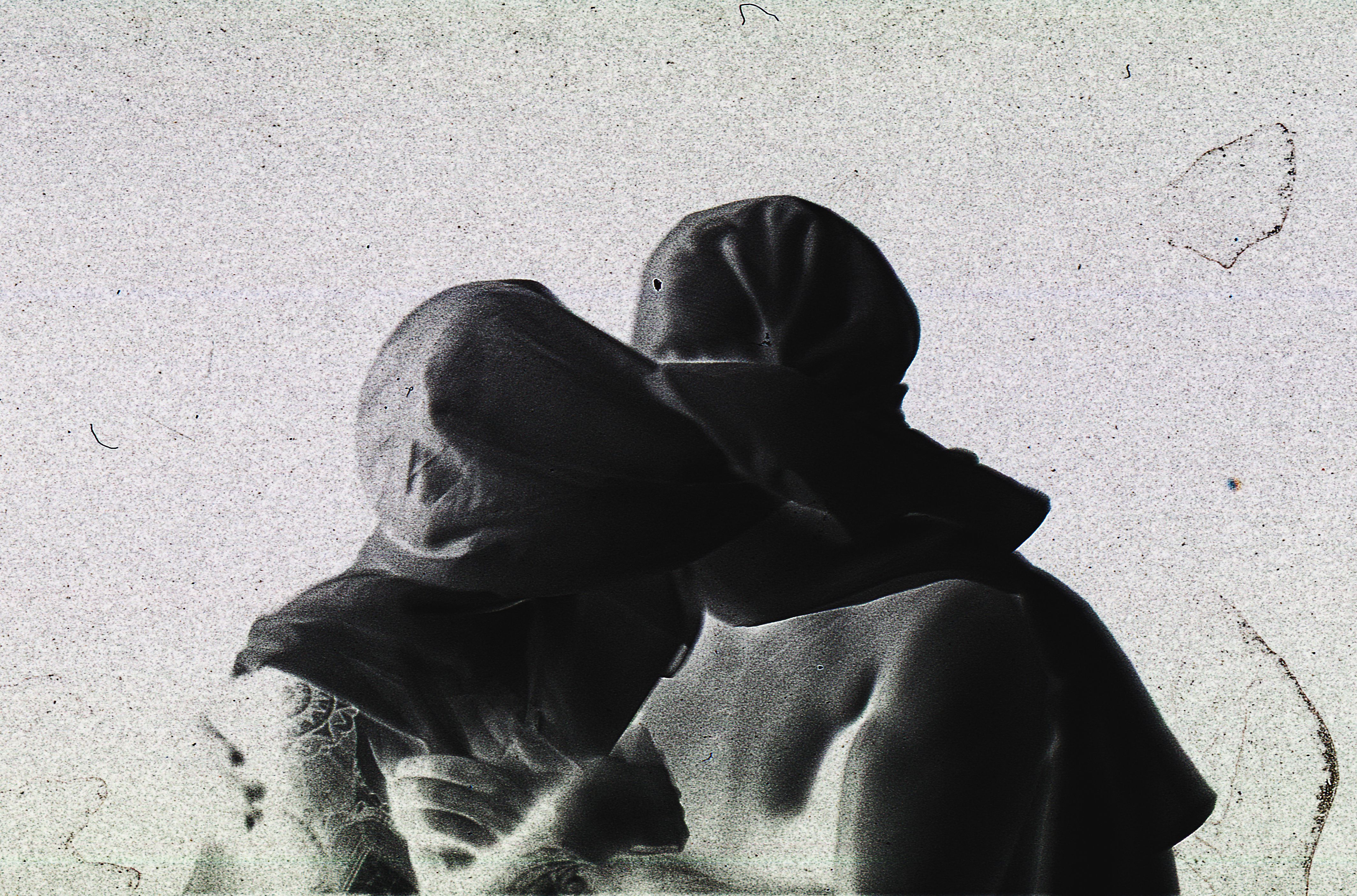 Negative Black and White Grainy Photo of Couple with Cloth over their ...