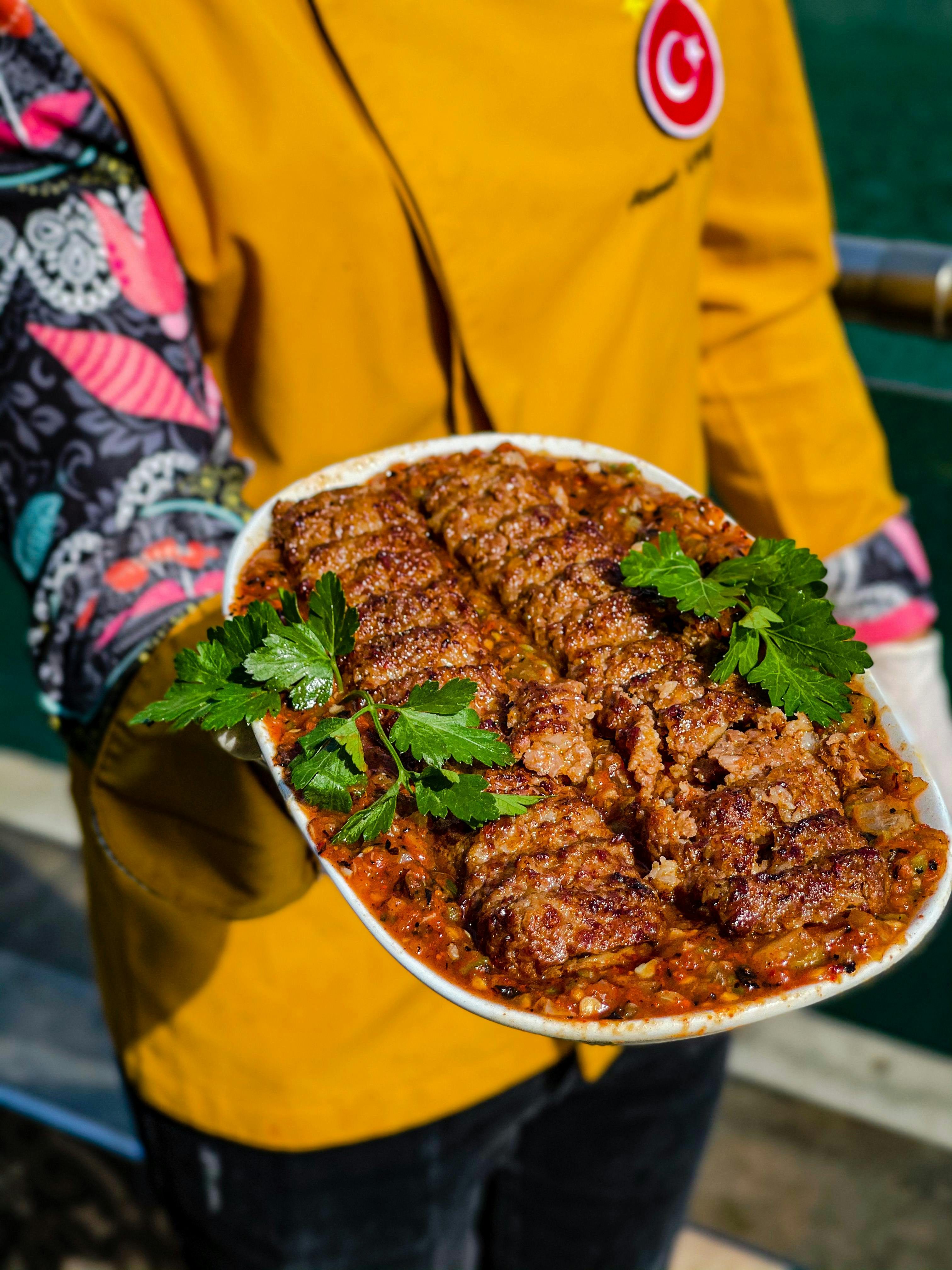 Midsection of a Person Holding a Plate of Ready-To-Eat Cooked Meat ...