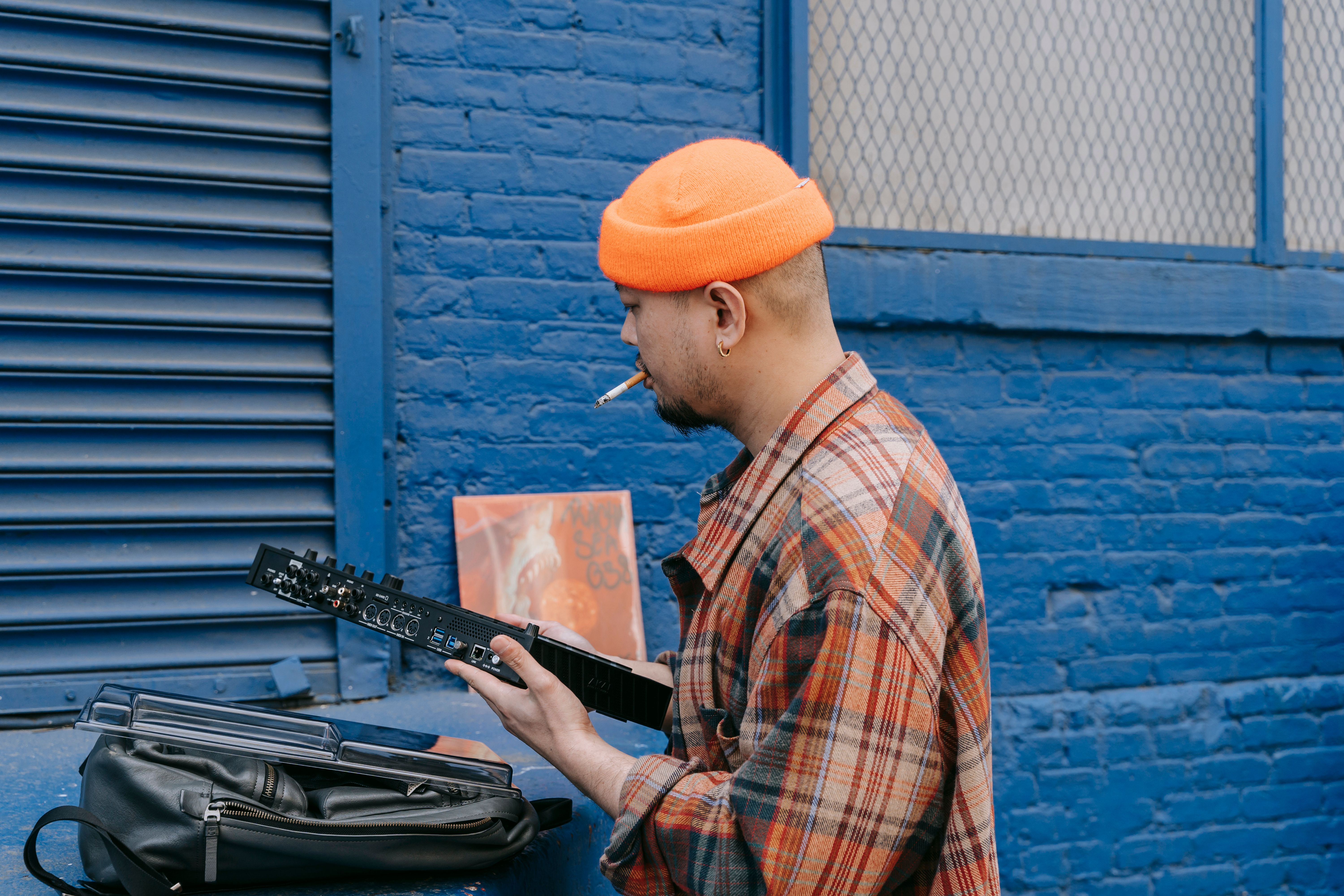 Man Wearing an Orange Beanie Hat with Cigarette · Free Stock Photo