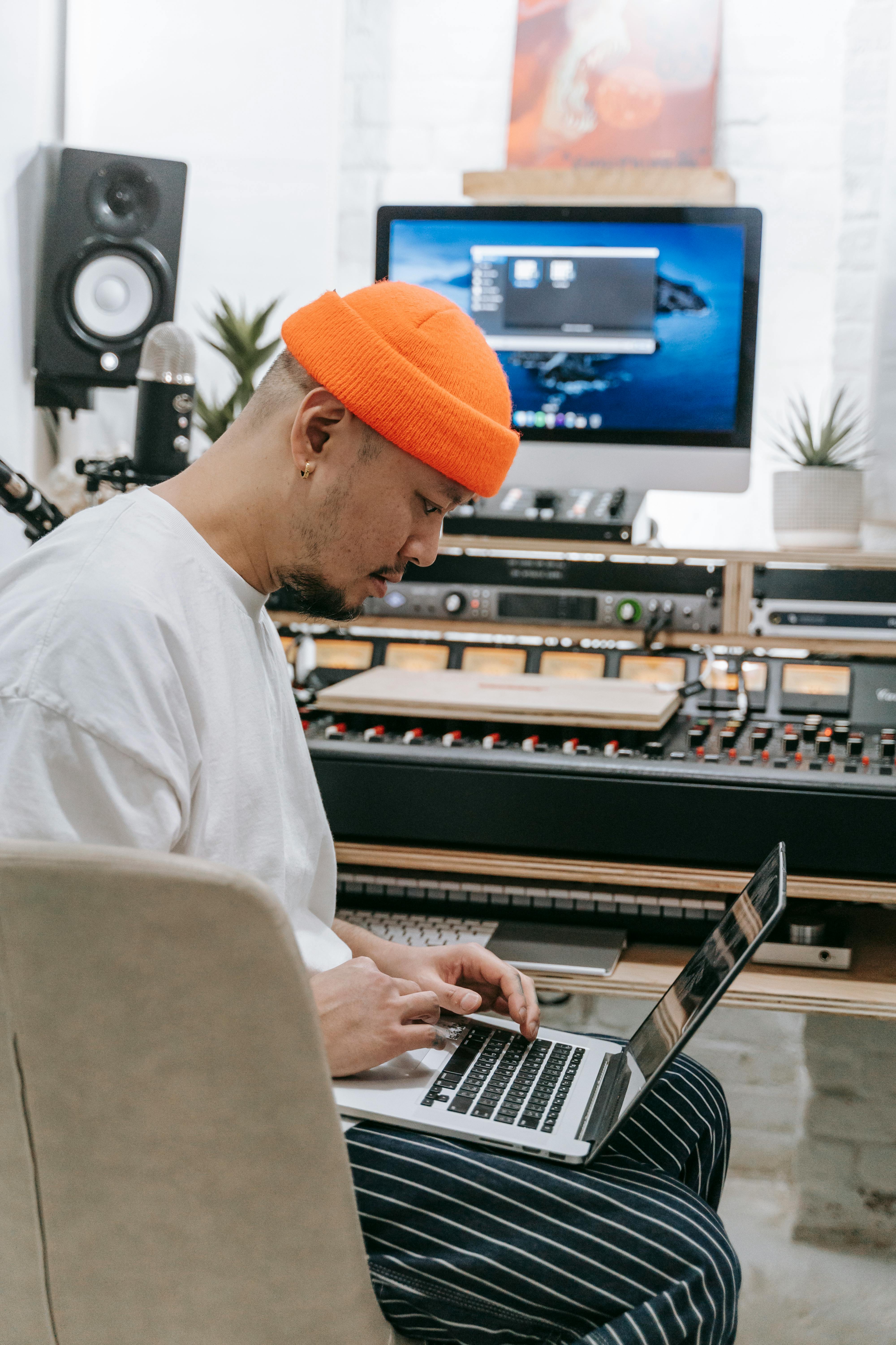 Man Wearing Orange Beanie Using Laptop · Free Stock Photo