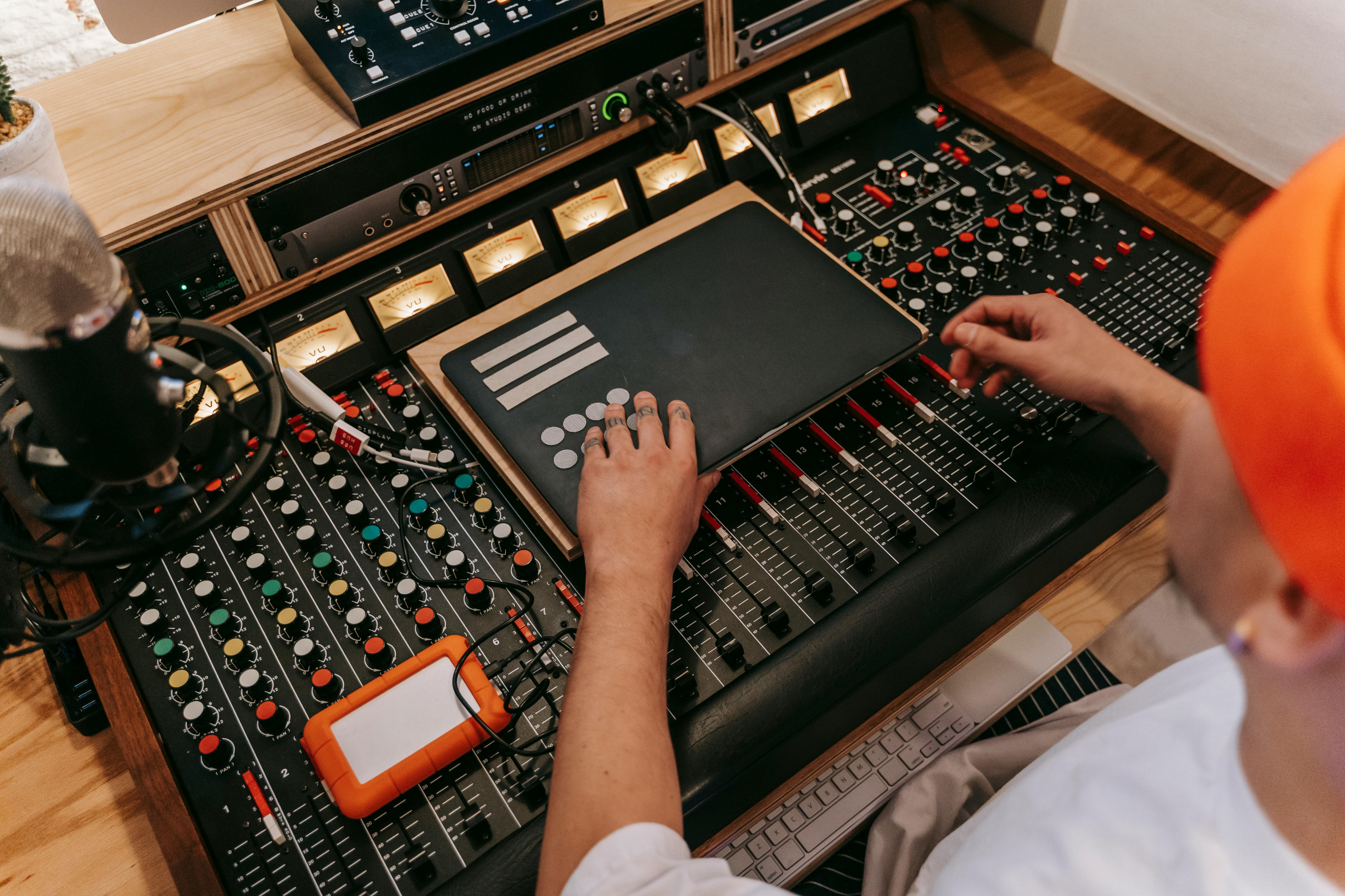 High Angle view of a Man Using a Sound Mixer · Free Stock Photo