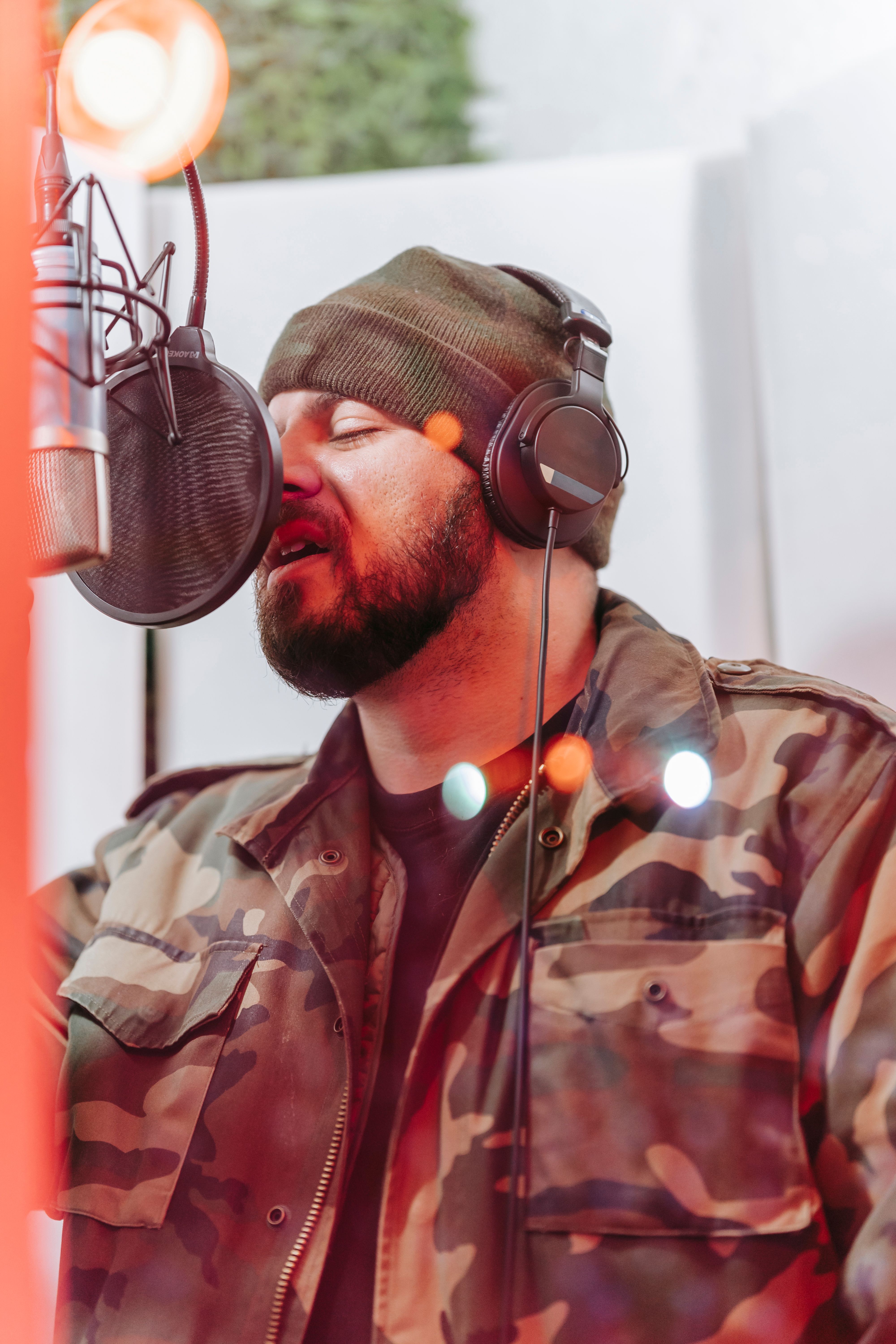 A Recording Artist Wearing a Camouflage Print Jacket · Free Stock Photo