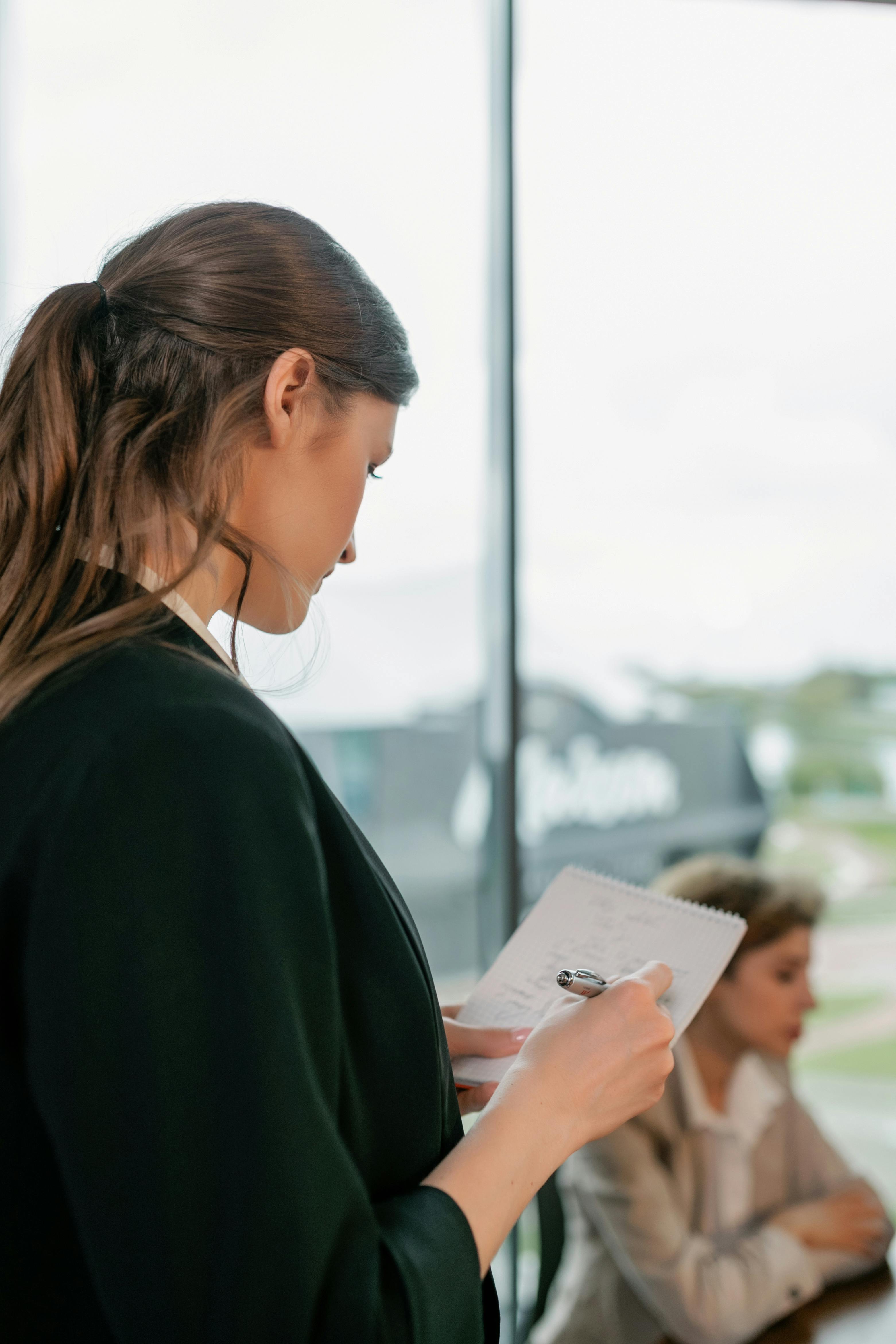 Woman Sitting with Notes in Park · Free Stock Photo