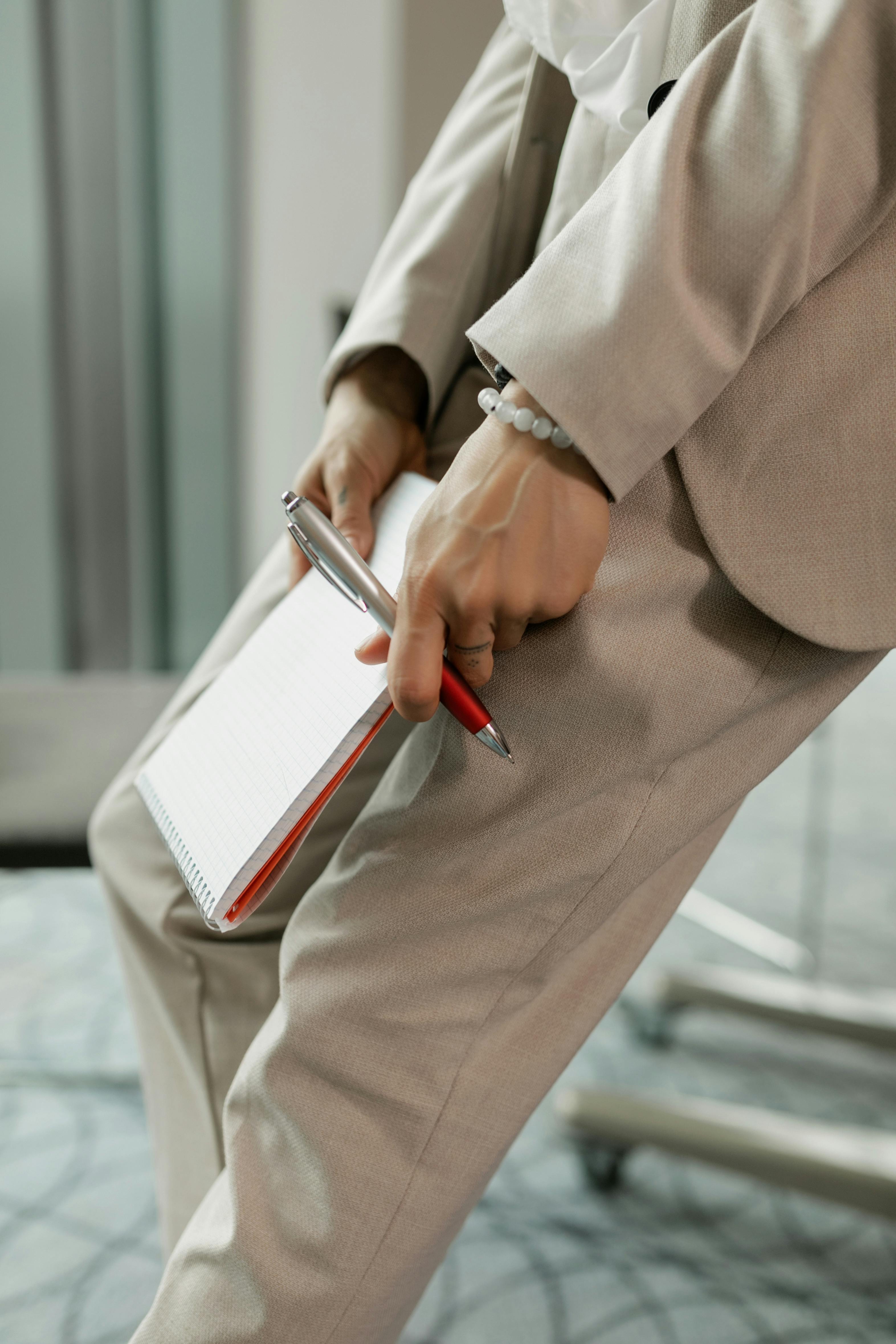Person Writing Notes on White Ruled Paper · Free Stock Photo