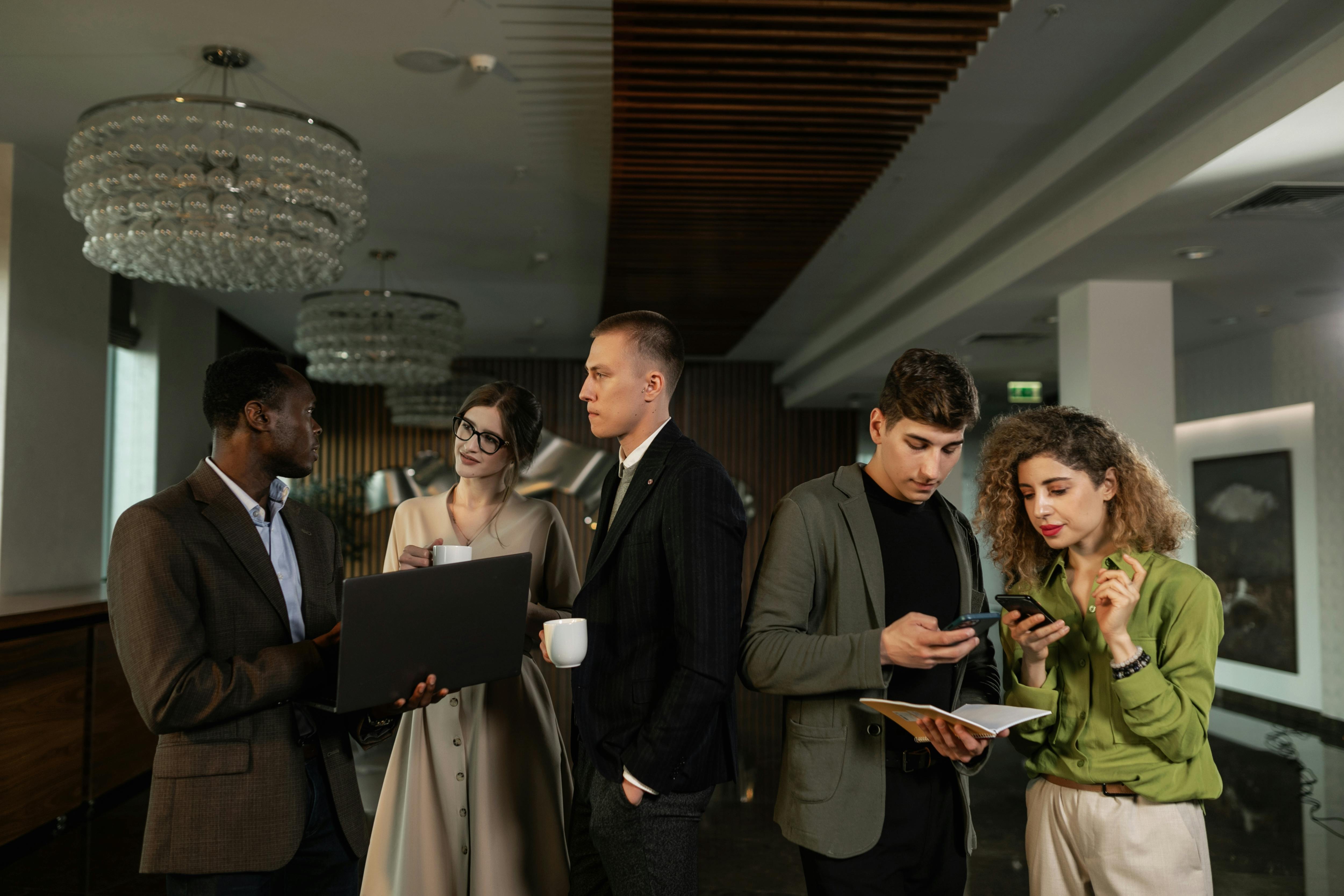 Person Using Smartphone and Laptop · Free Stock Photo