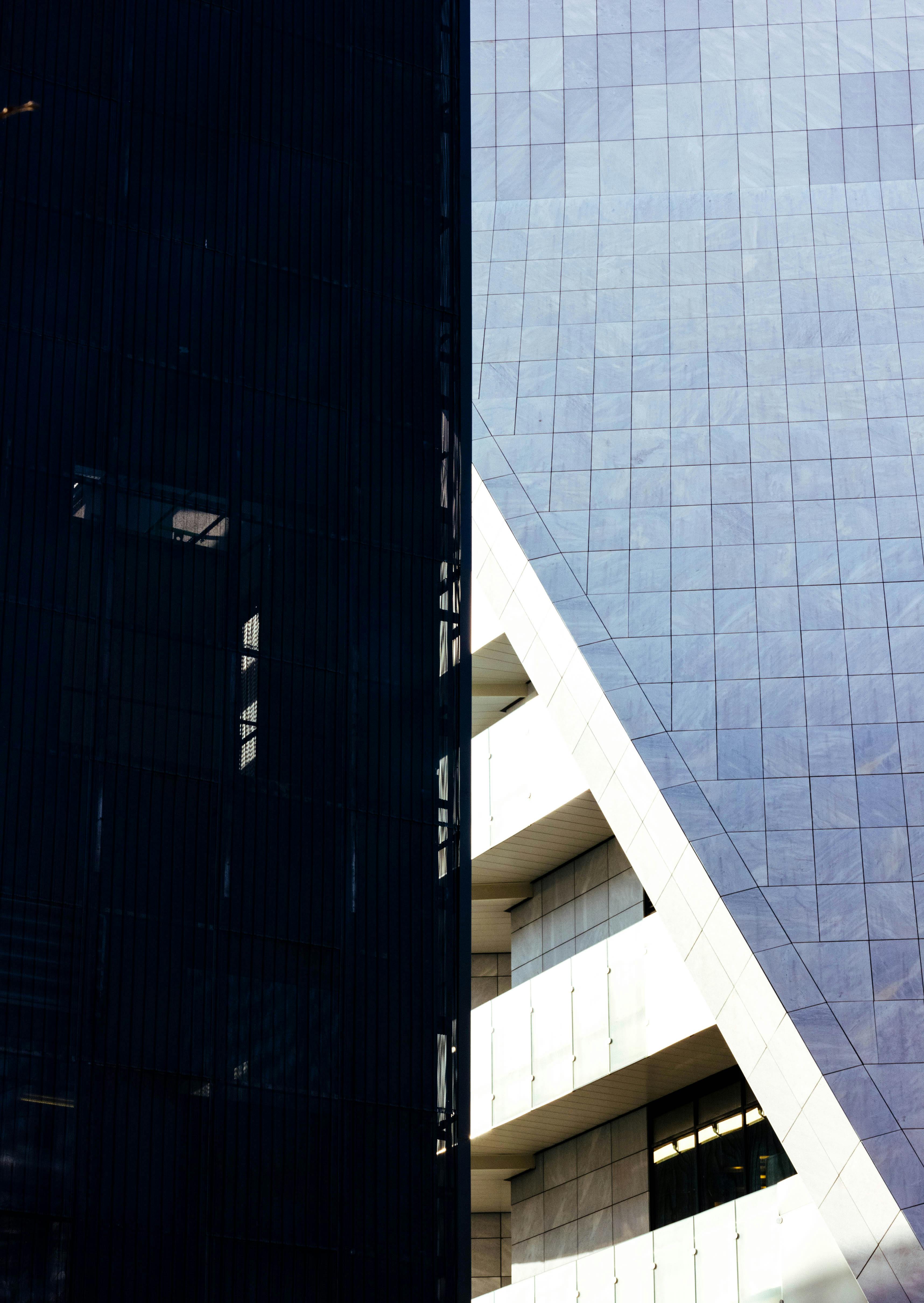 Low Angle Photography of Blue Tinted Glass Buildings · Free Stock Photo