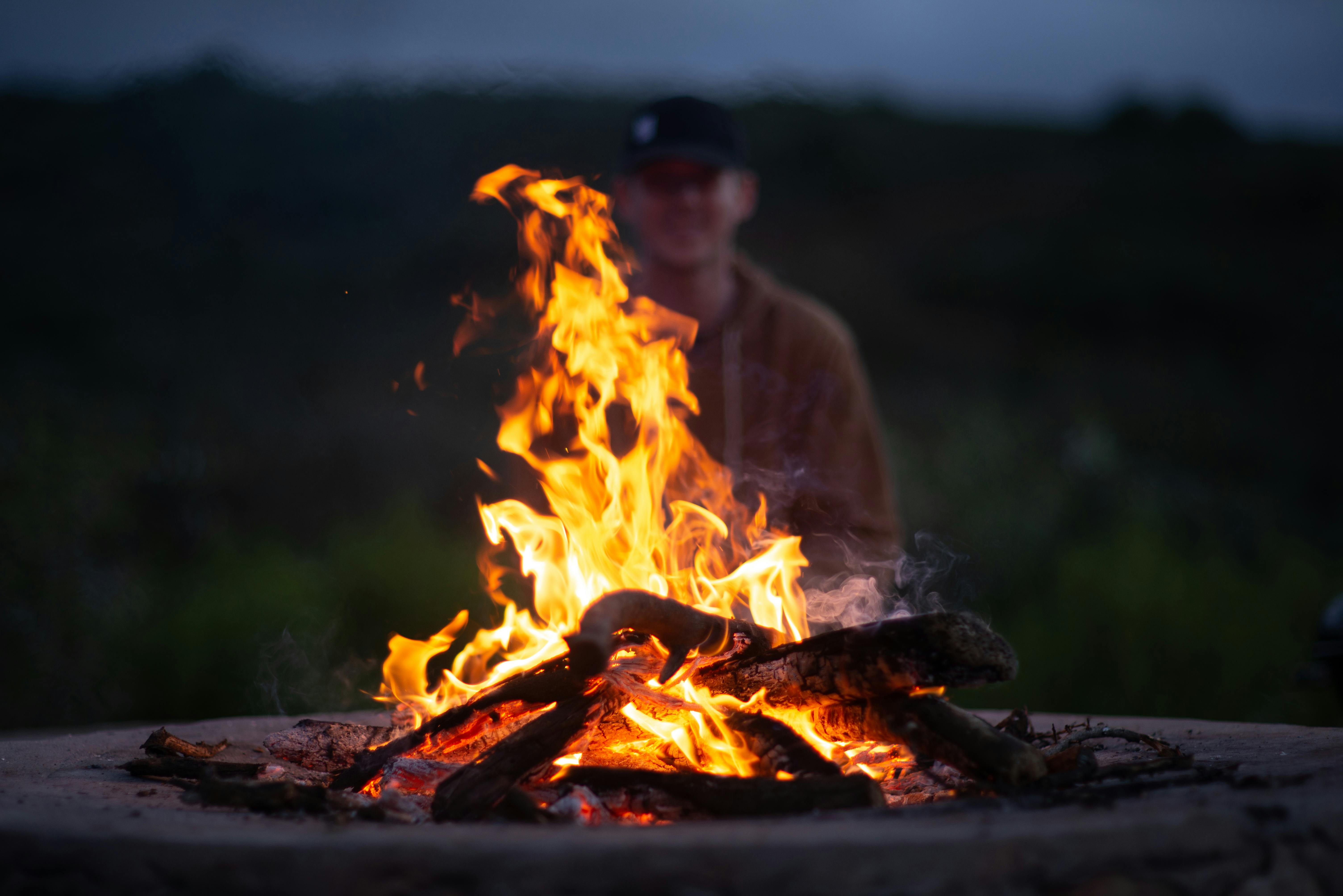 Burning newspaper revealing man face on other side · Free Stock Photo