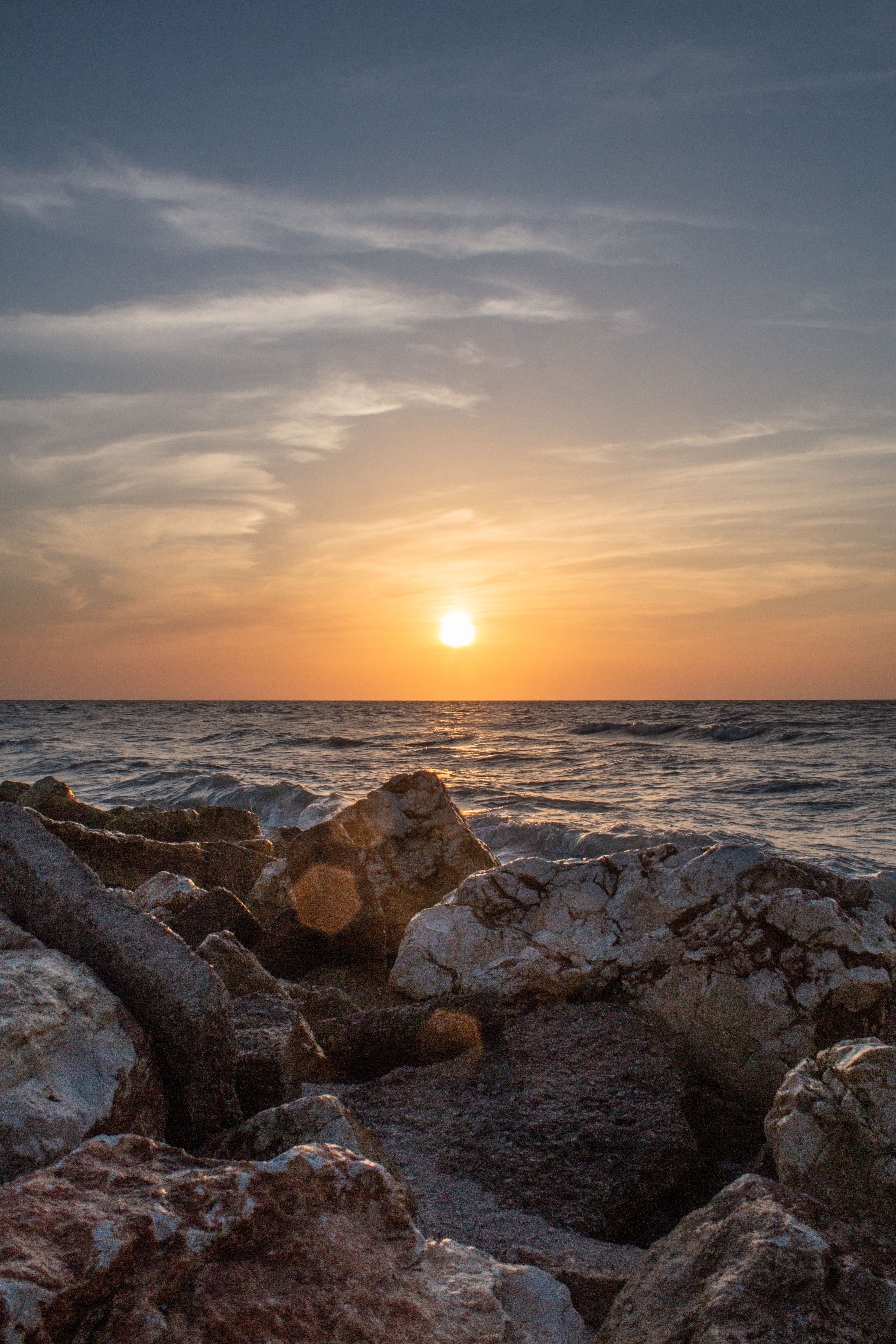 Gray Rocks Near Body of Water During Sunset · Free Stock Photo