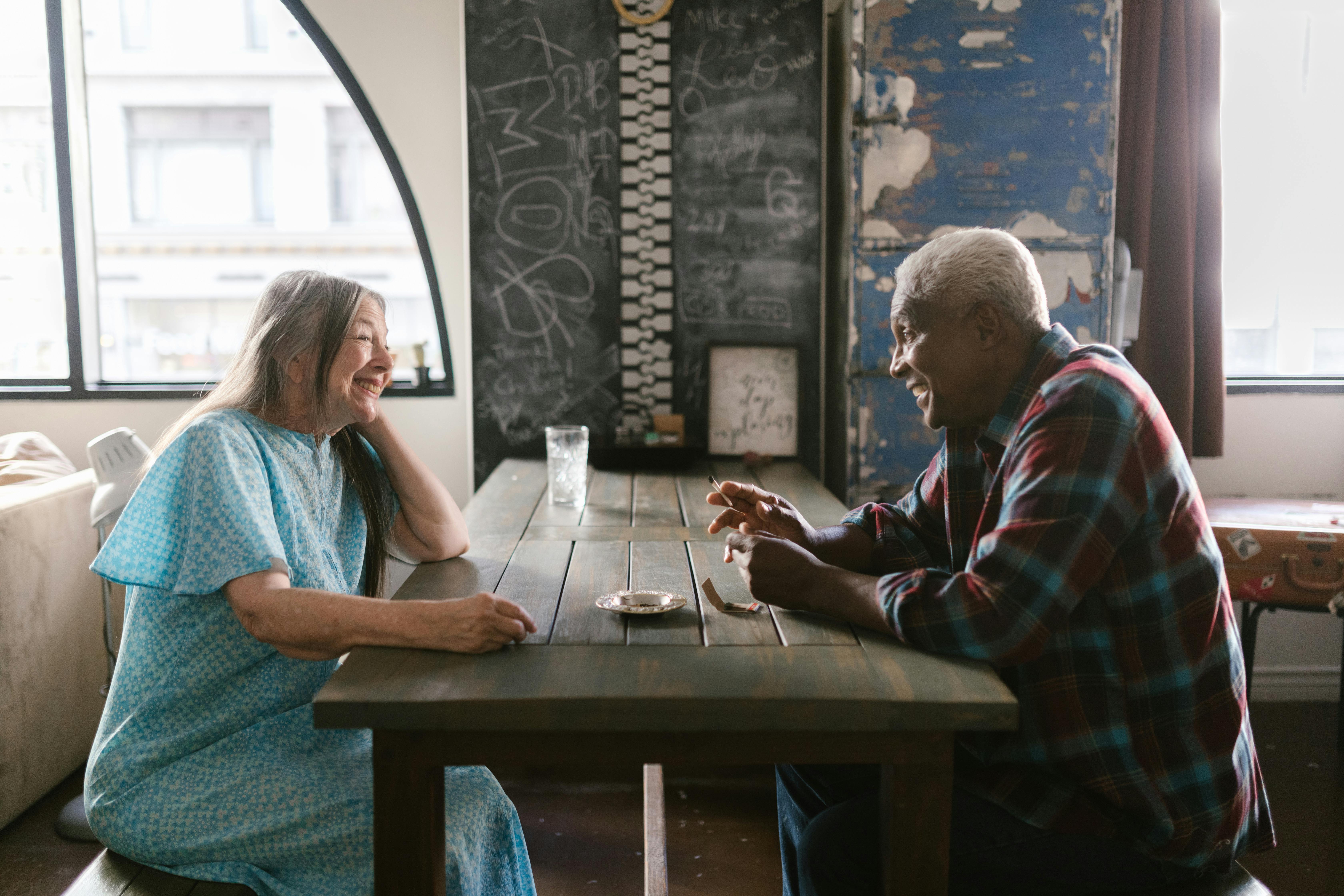 Man and Woman Sitting at Table · Free Stock Photo