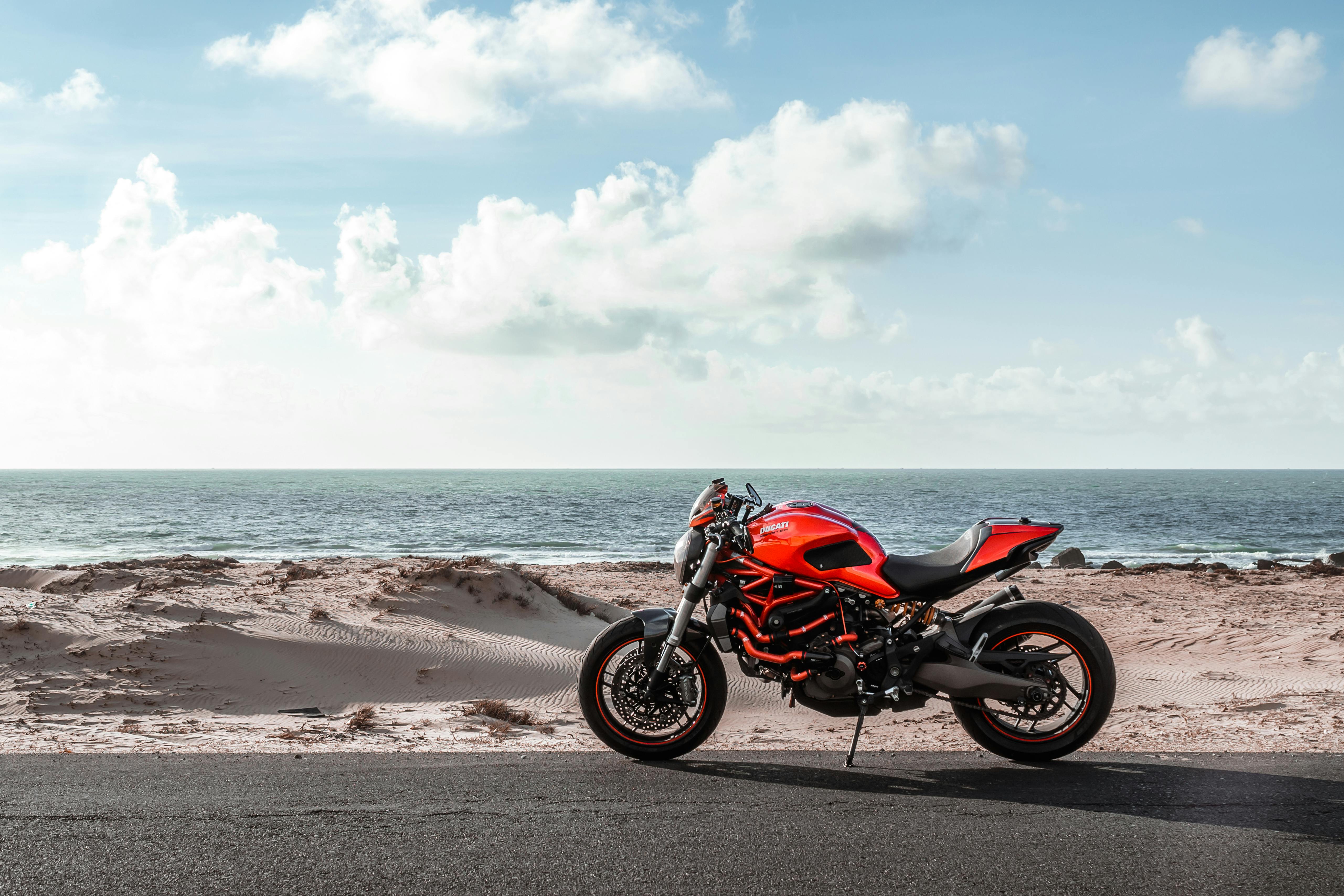 Red Motorcycle Near a Beach · Free Stock Photo