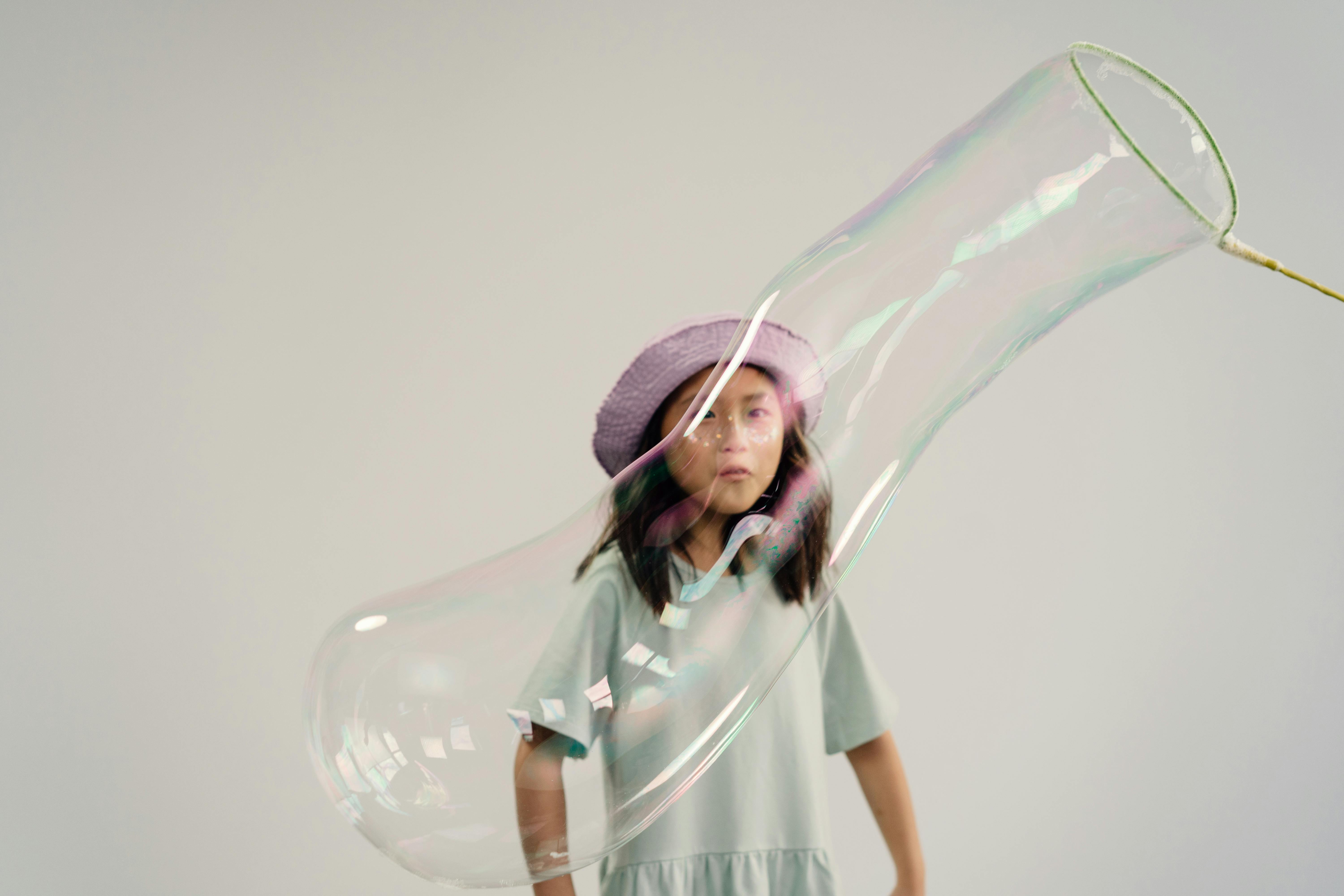 A Little Girl Looking at a Huge Bubble · Free Stock Photo