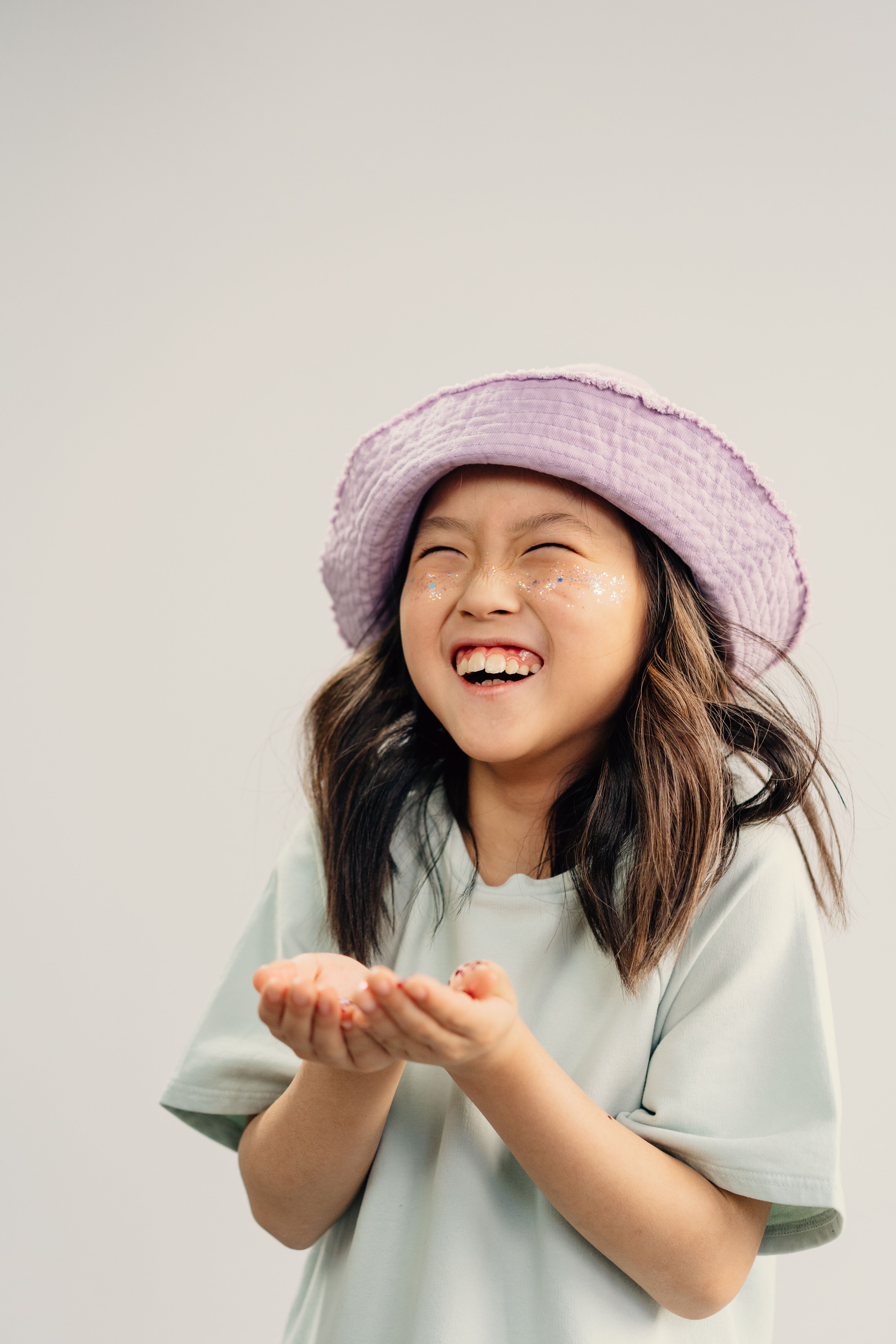 A Happy Little Girl with her Hands Out · Free Stock Photo