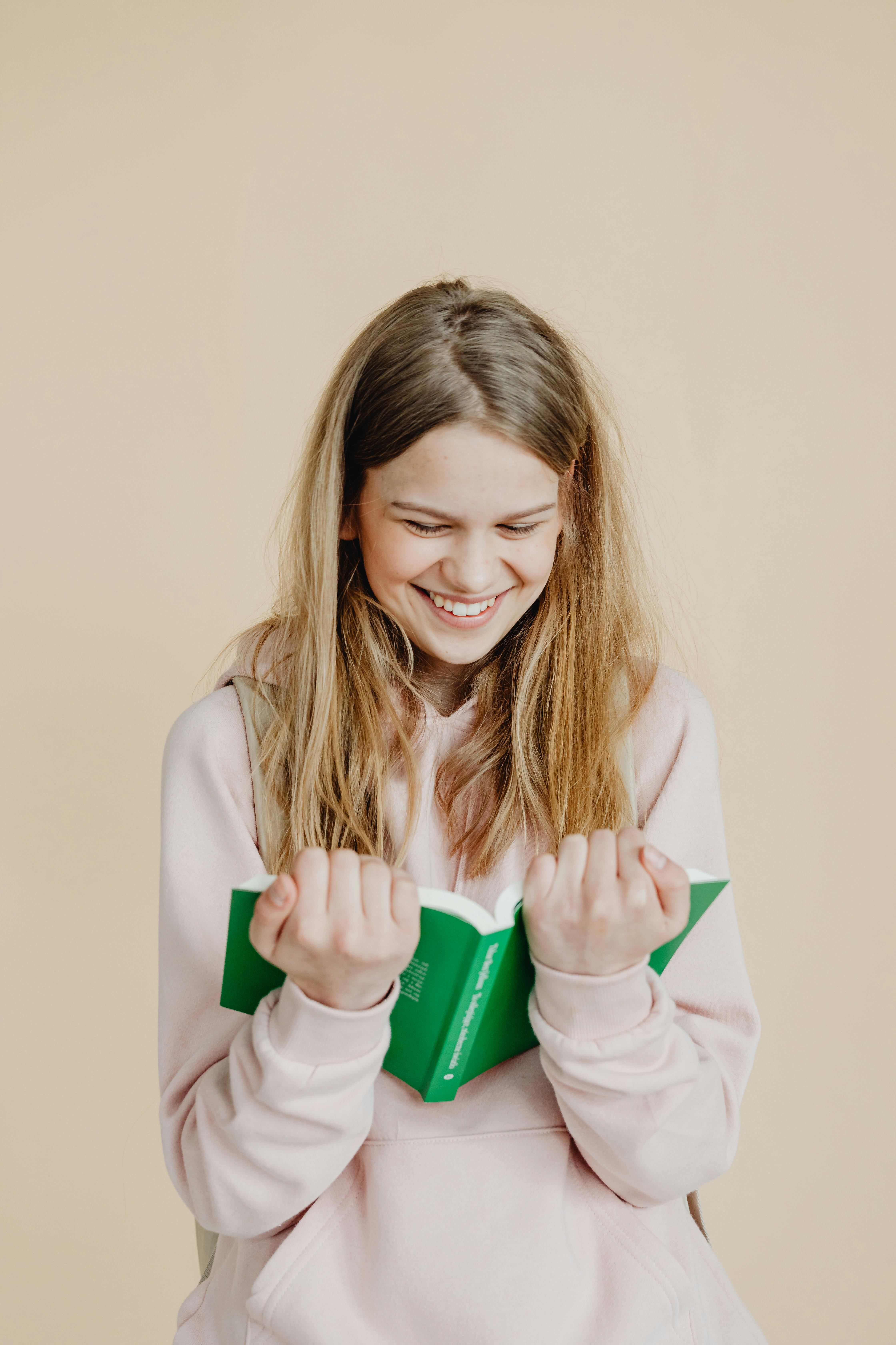 A Girl Holding a Book · Free Stock Photo