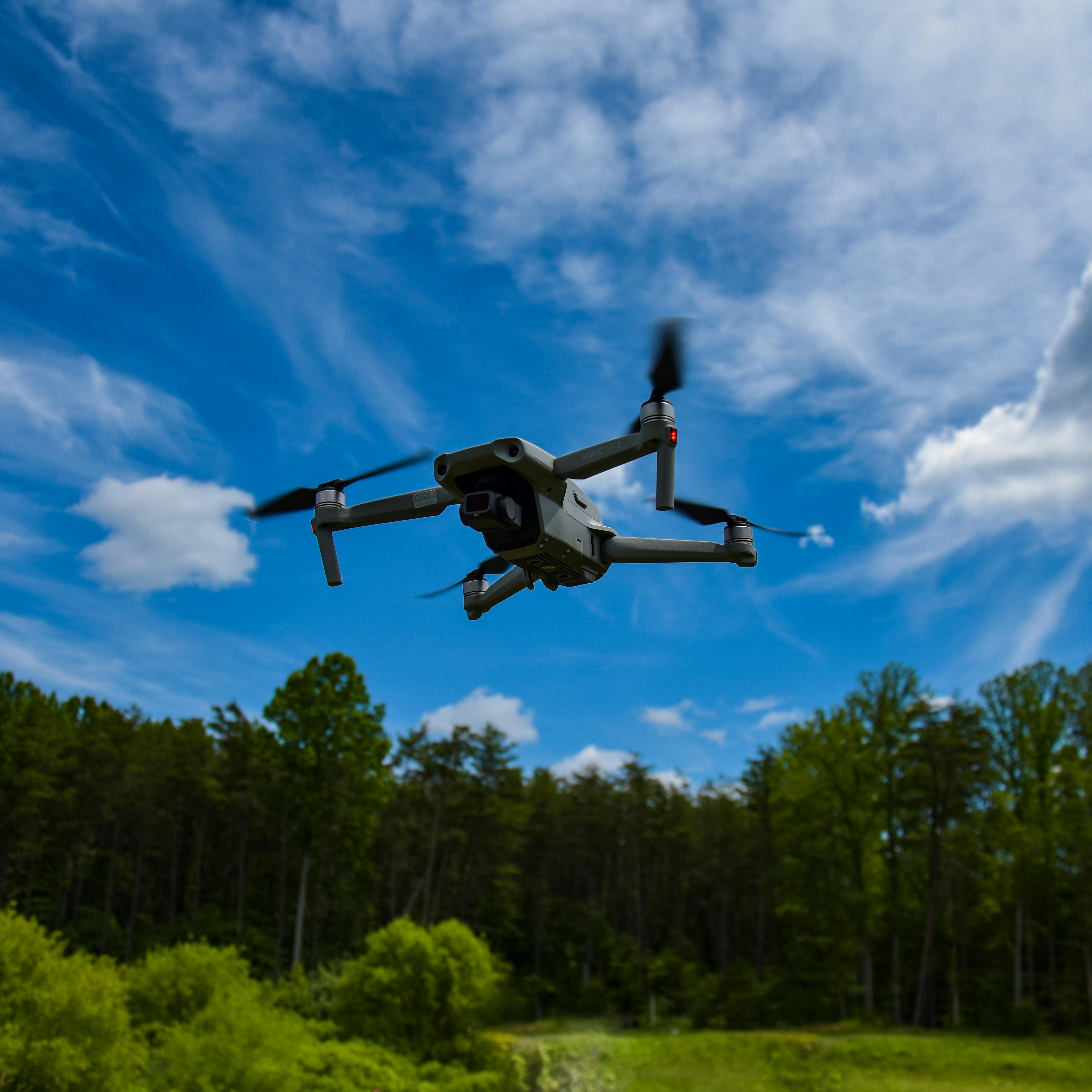 A Drone Flying Under the Blue Sky and White Clouds · Free Stock Photo