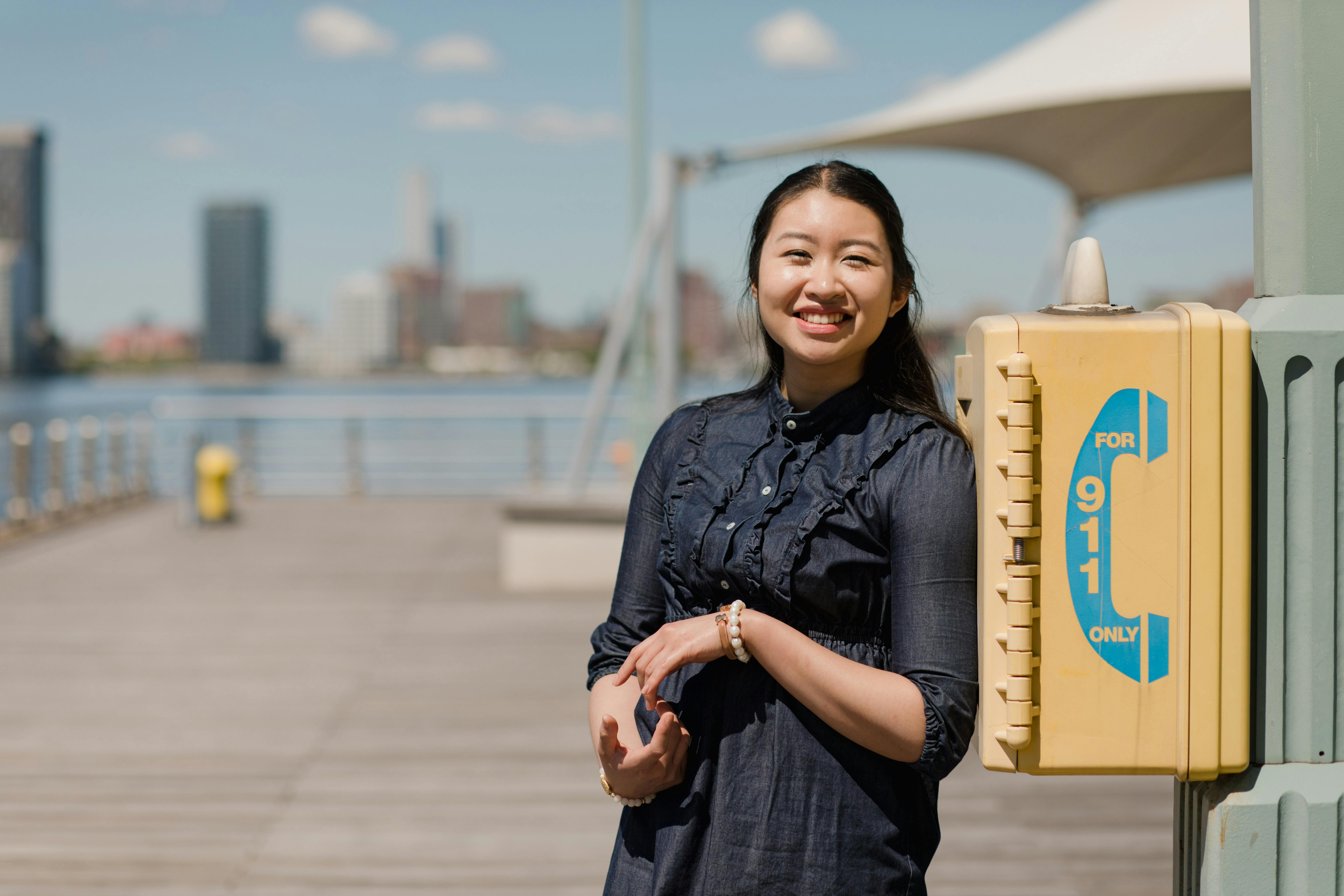 Woman in Blue Dress Standing Near Telephone Box · Free Stock Photo