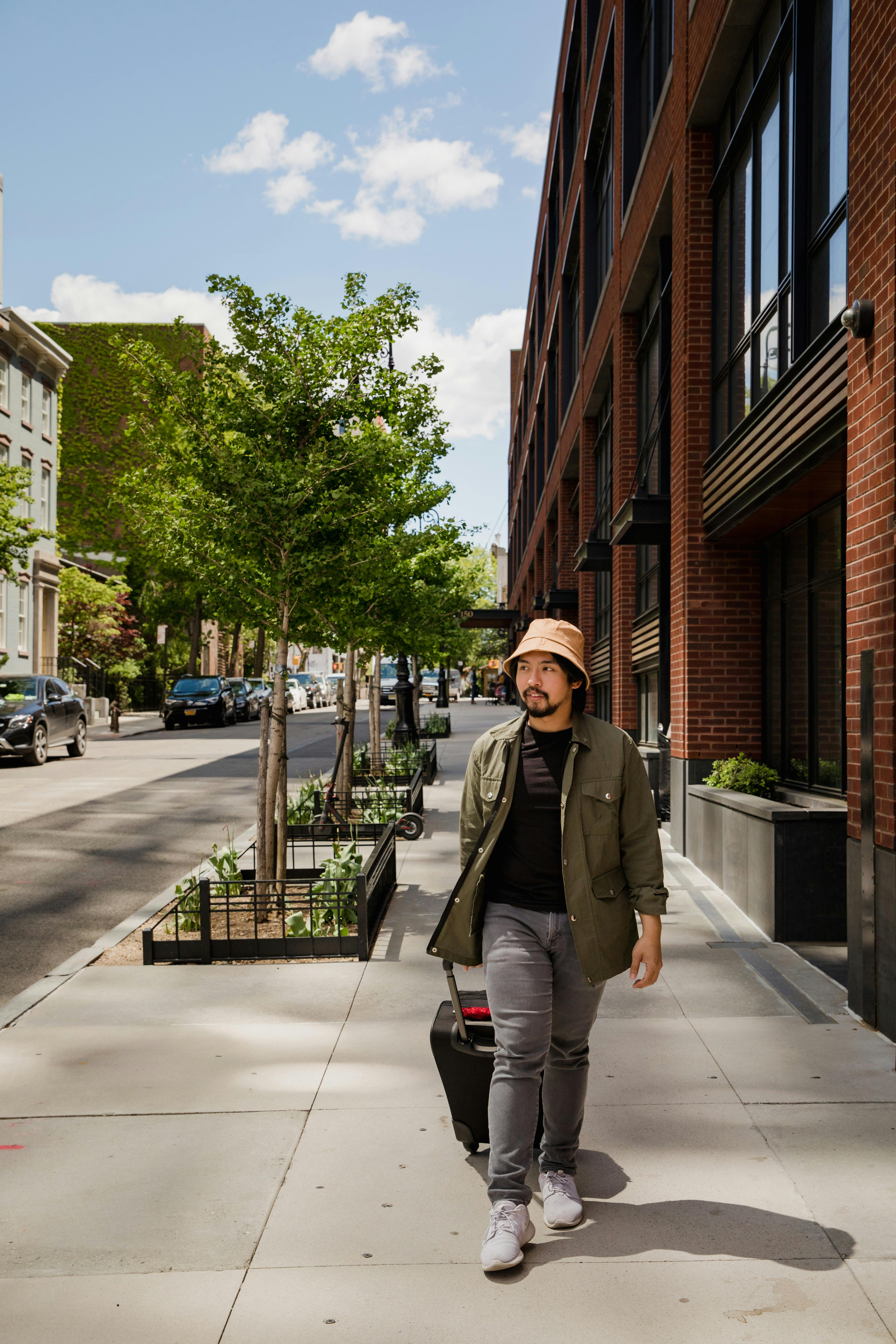 Man Walking on Sidewalk with Laggage · Free Stock Photo