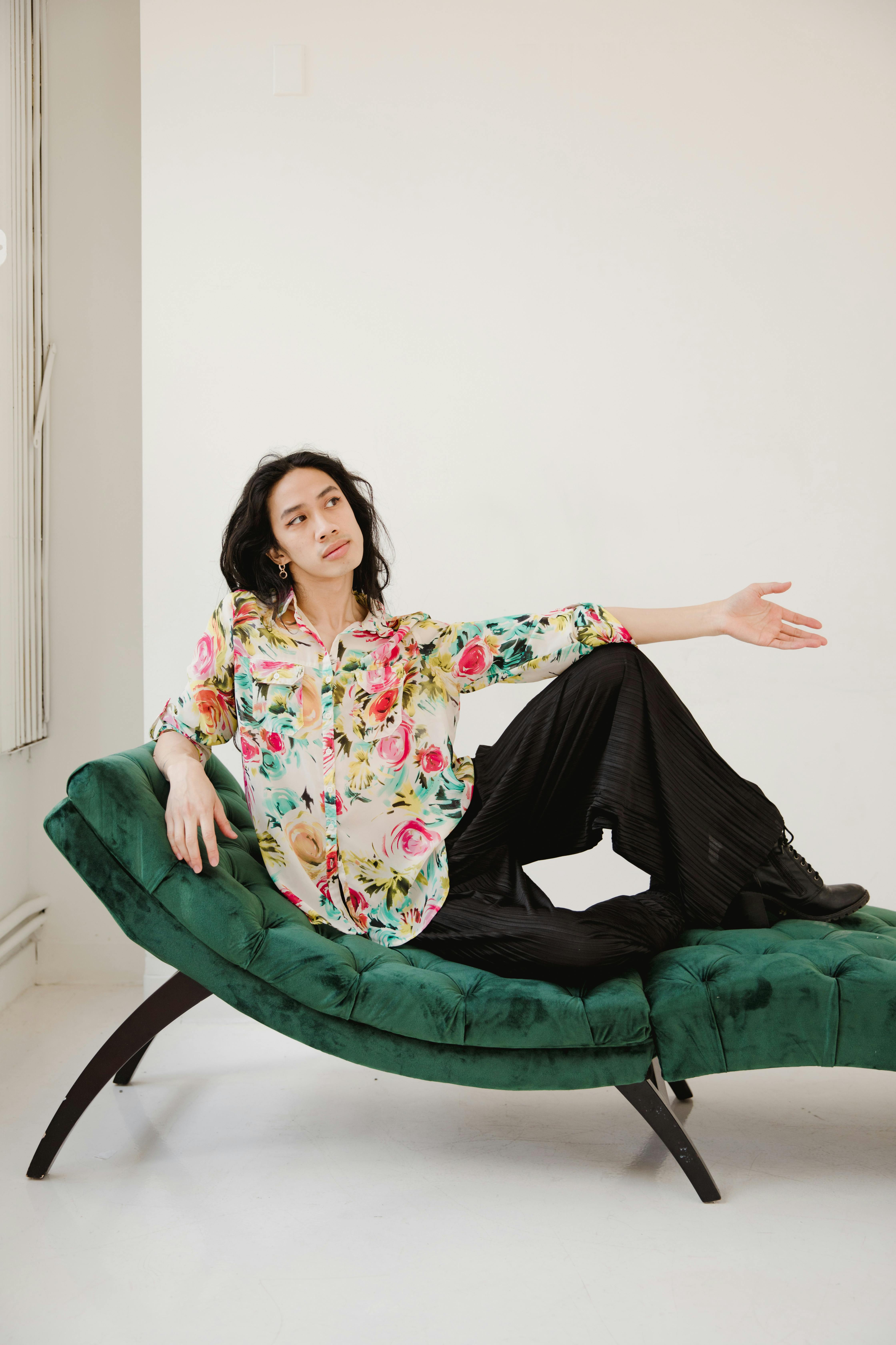 A Woman in Floral Top and Black Pants Sitting on the Couch · Free Stock ...