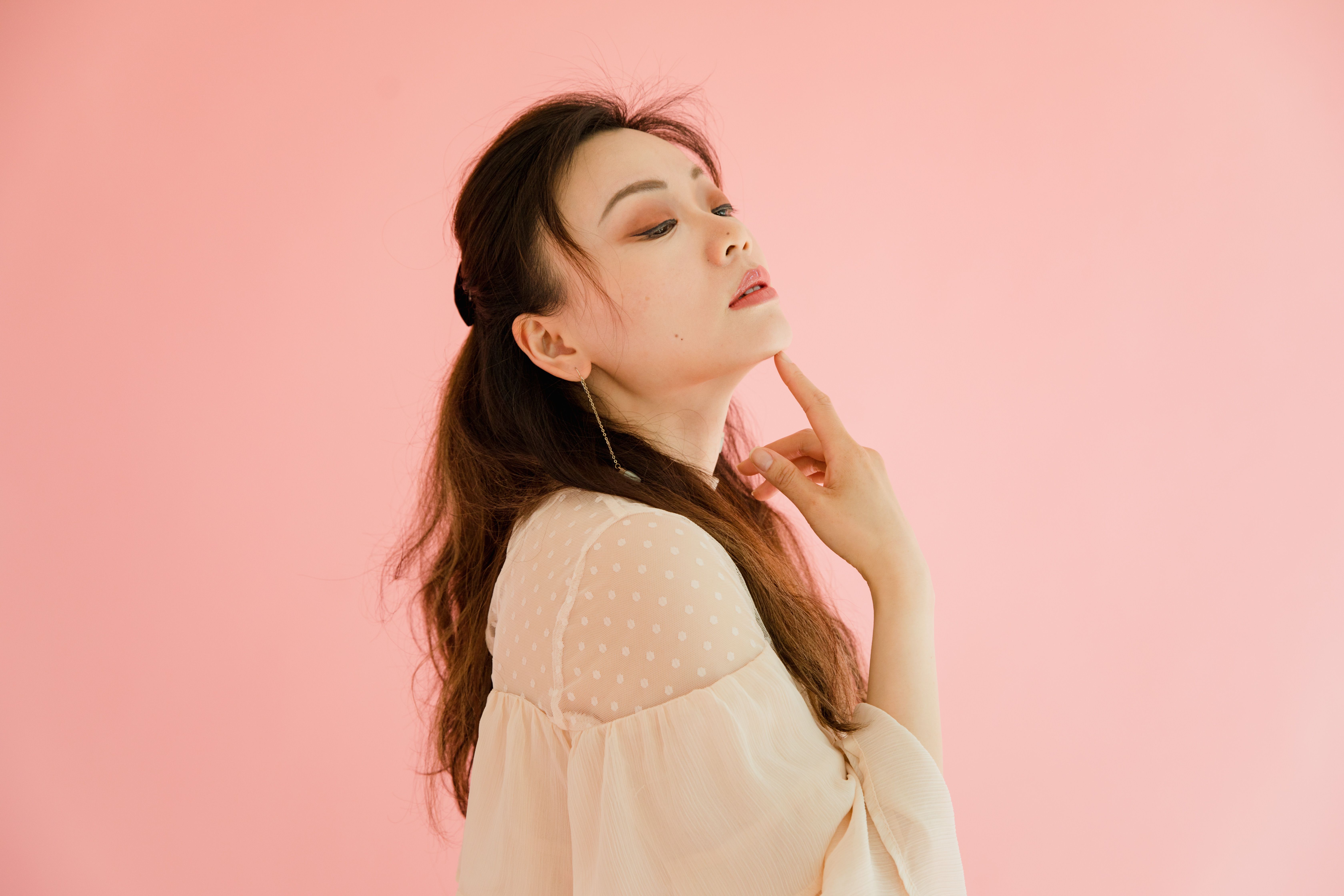 A Woman Pointing her Chin · Free Stock Photo