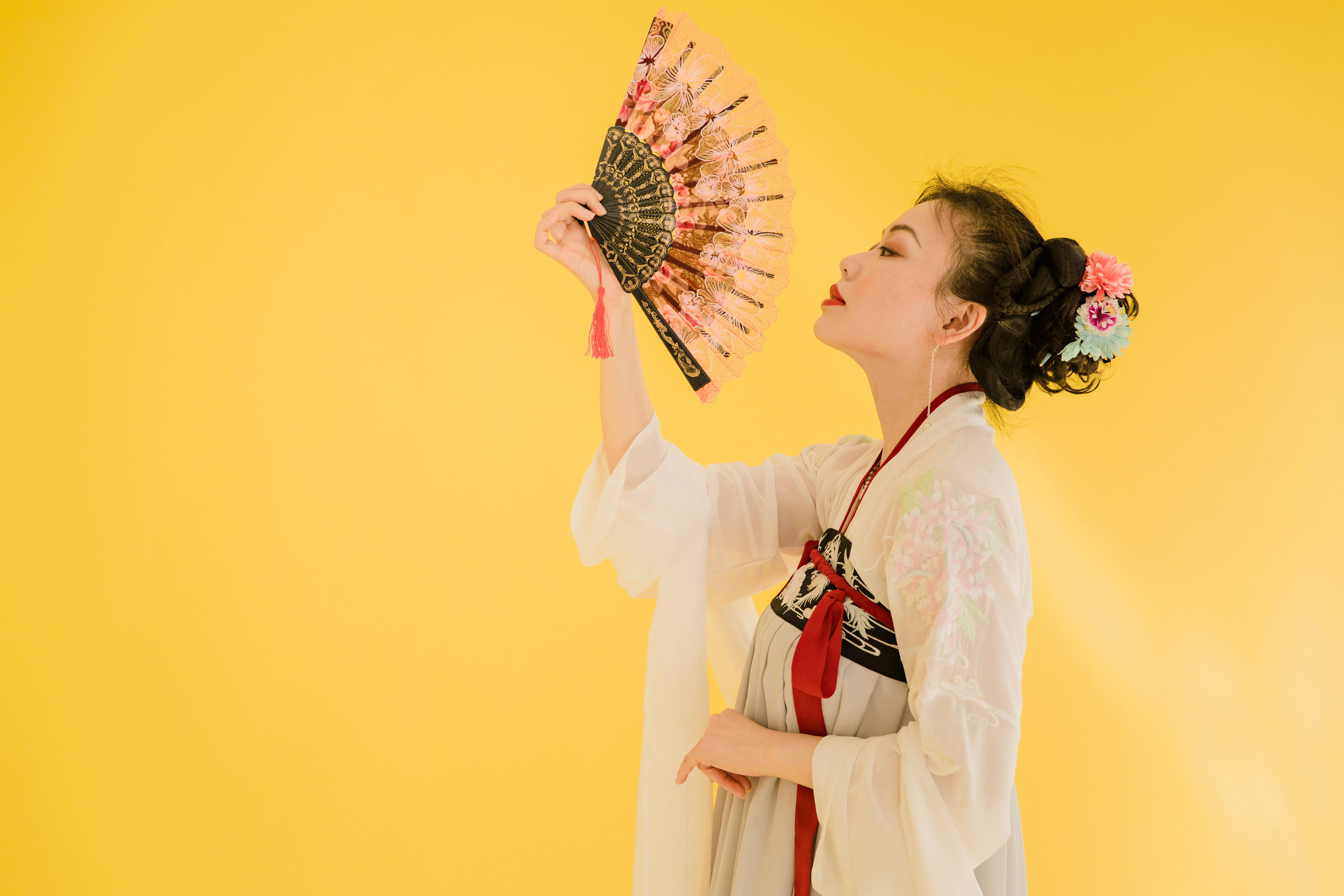 A Woman using Hand Fan · Free Stock Photo