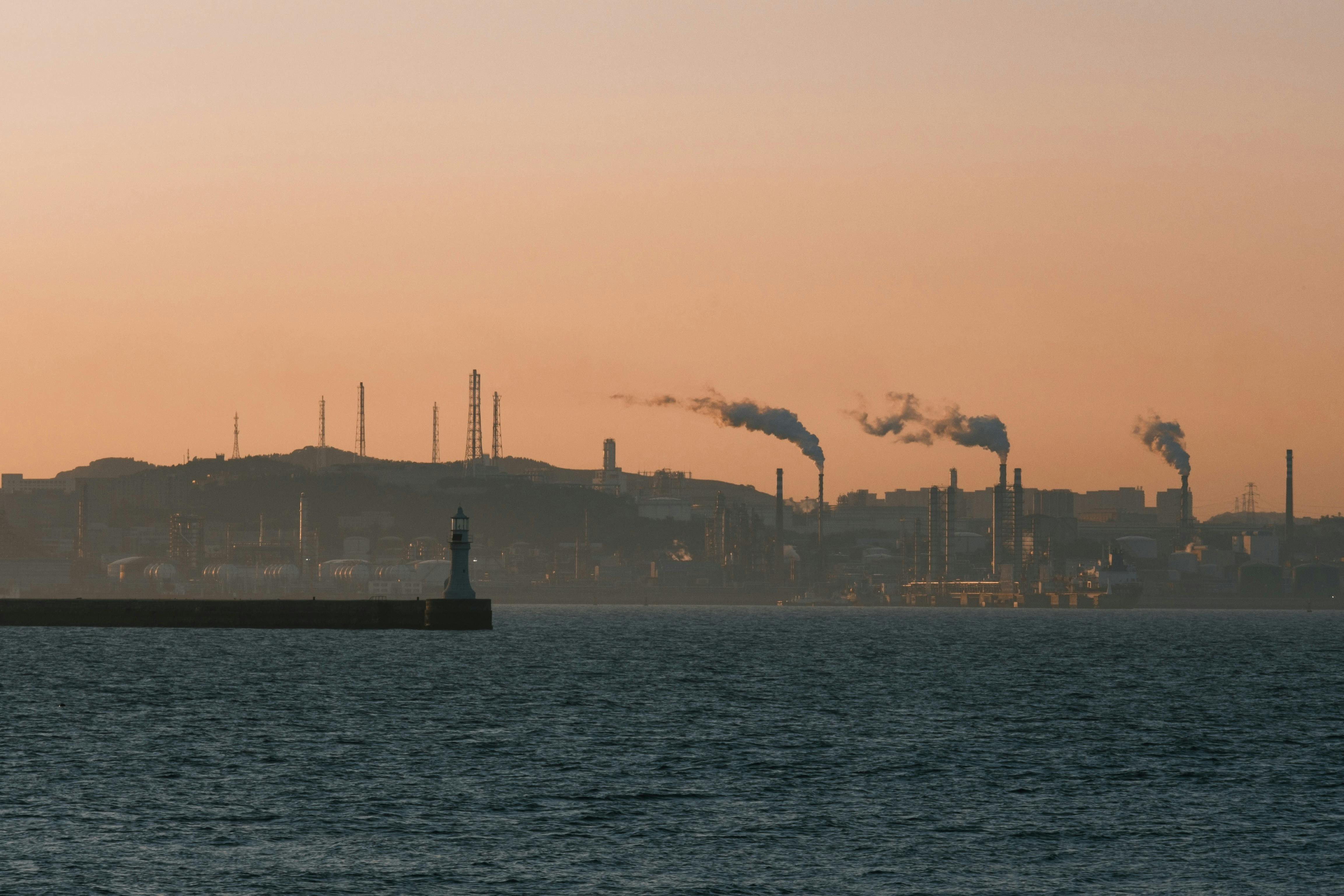 Factory Building Across the Ocean · Free Stock Photo