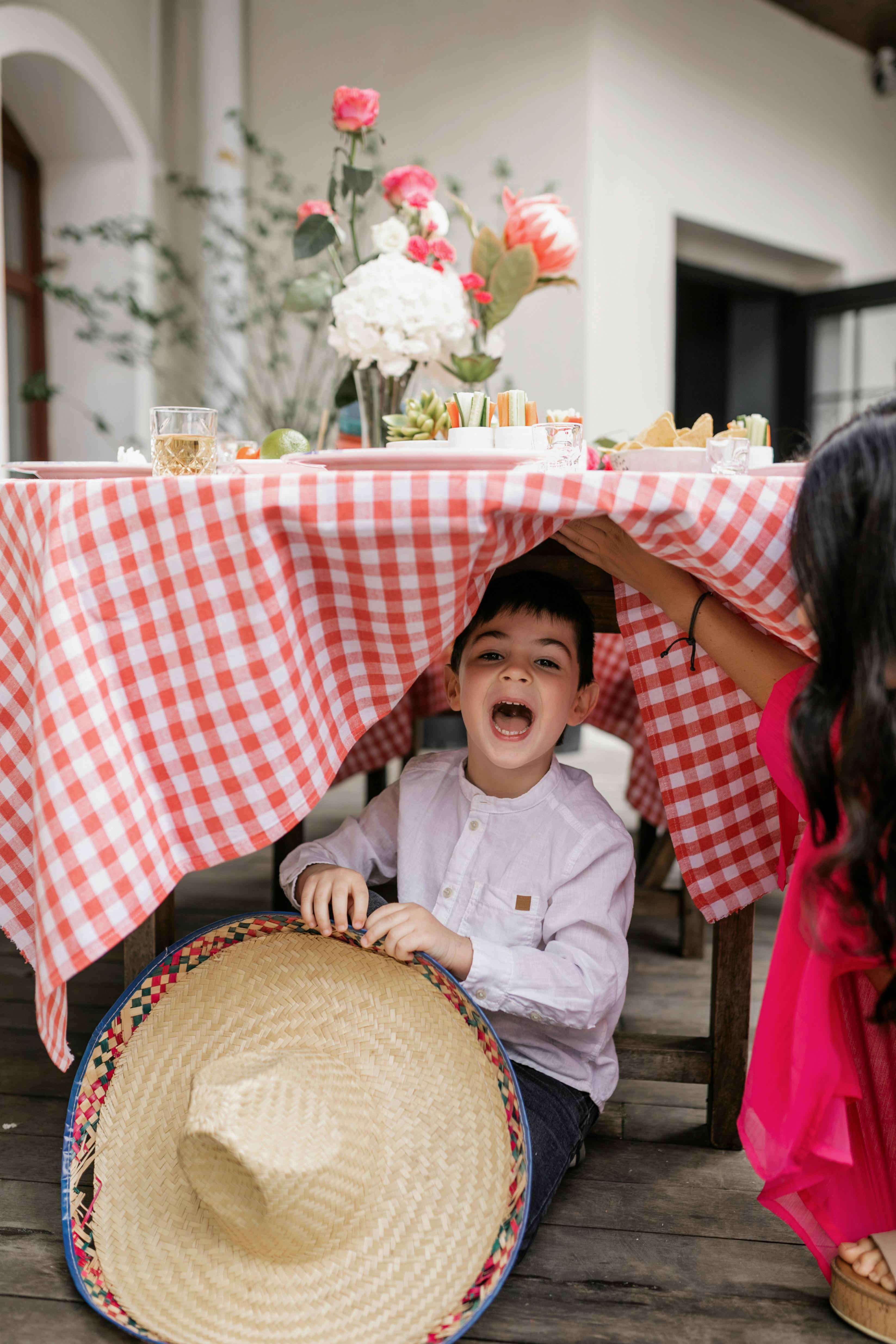 A Boy Sitting Under the Table · Free Stock Photo