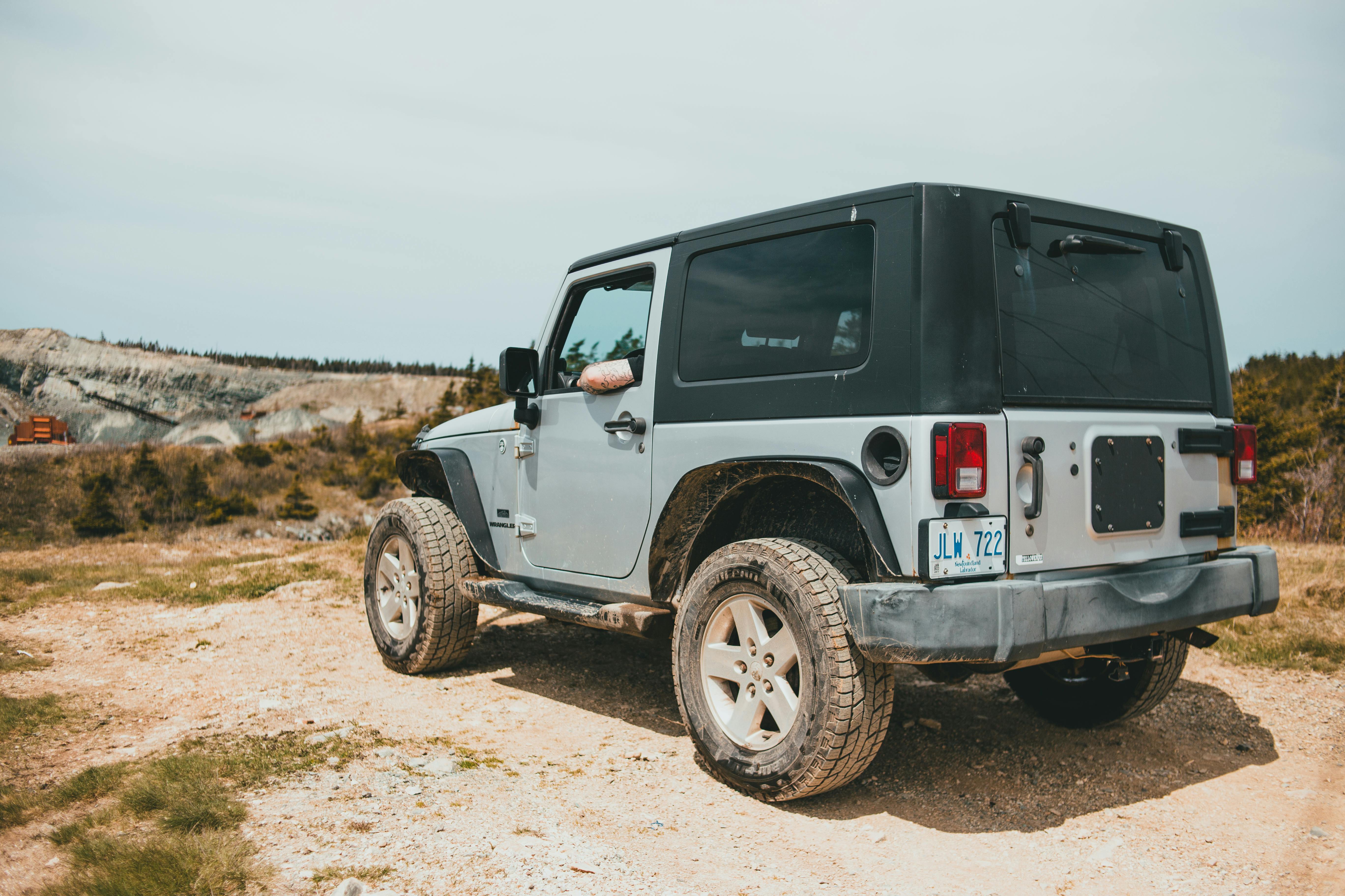 Orange and Black Tractor Next to Piles of Rocks · Free Stock Photo
