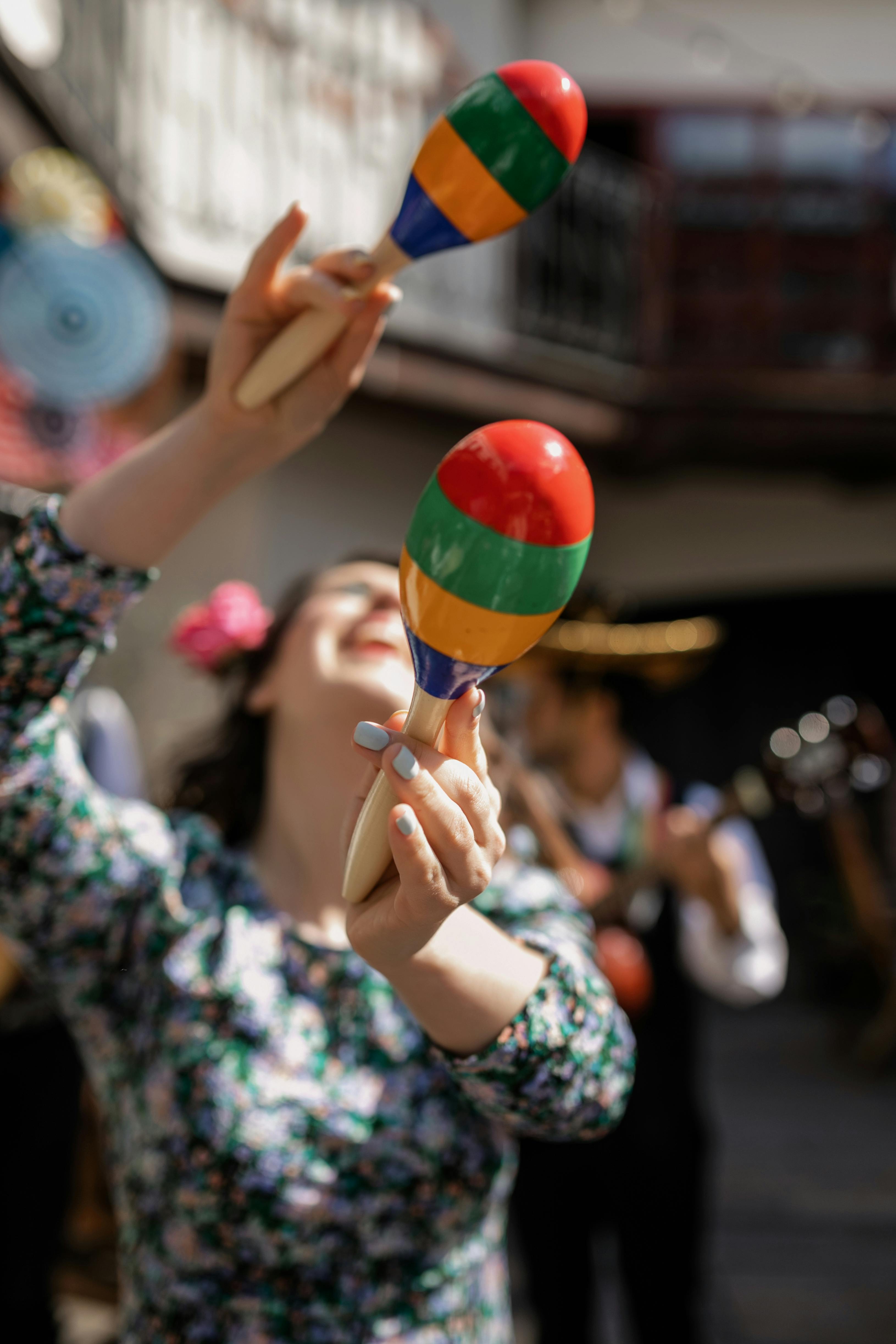 Woman in Floral Dress Playing Maracas · Free Stock Photo