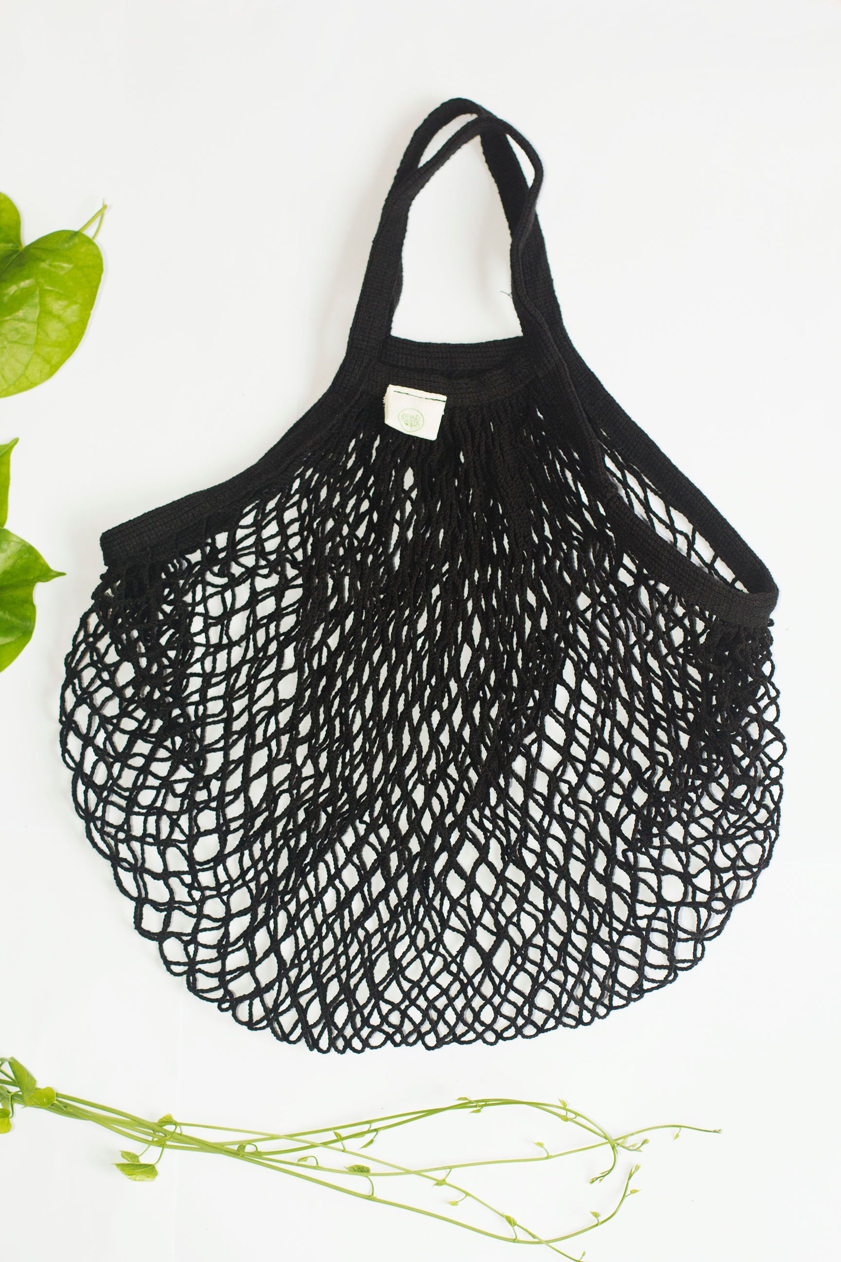 Black Mesh Bag on White Surface · Free Stock Photo