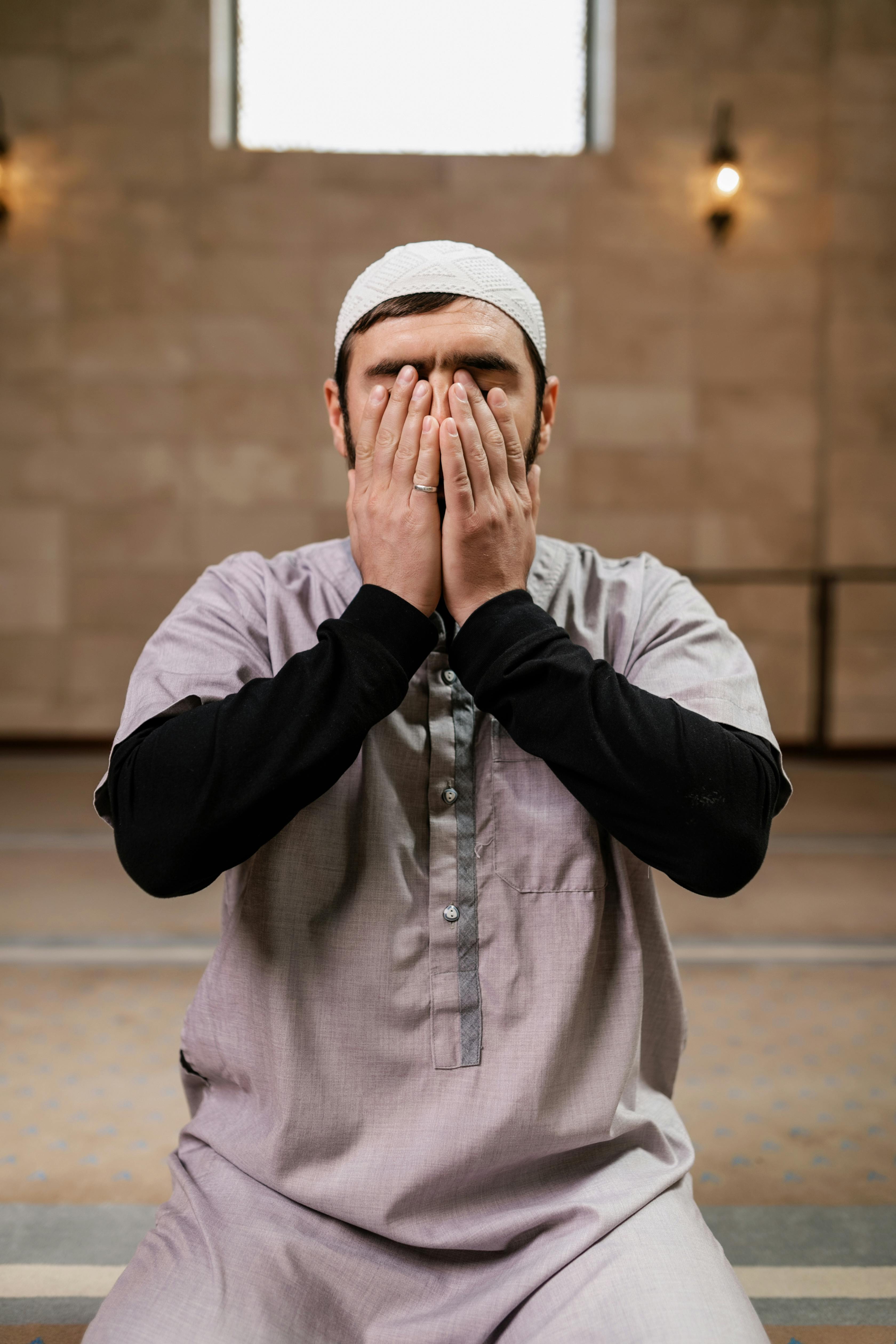 Man Kneeling at Mosque and Praying with Hands on Face · Free Stock Photo