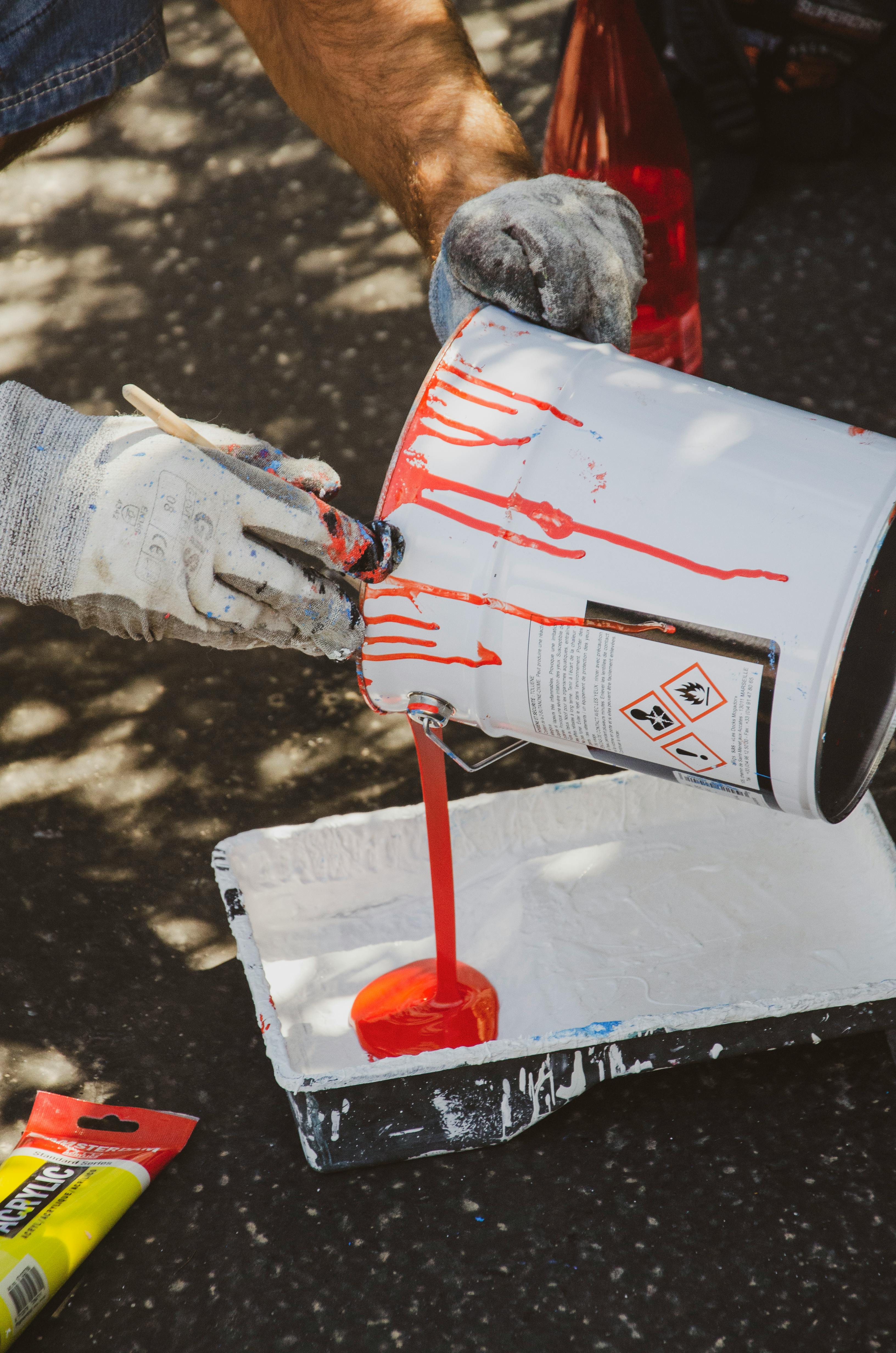 Person Pouring Red Paint on a Tray · Free Stock Photo